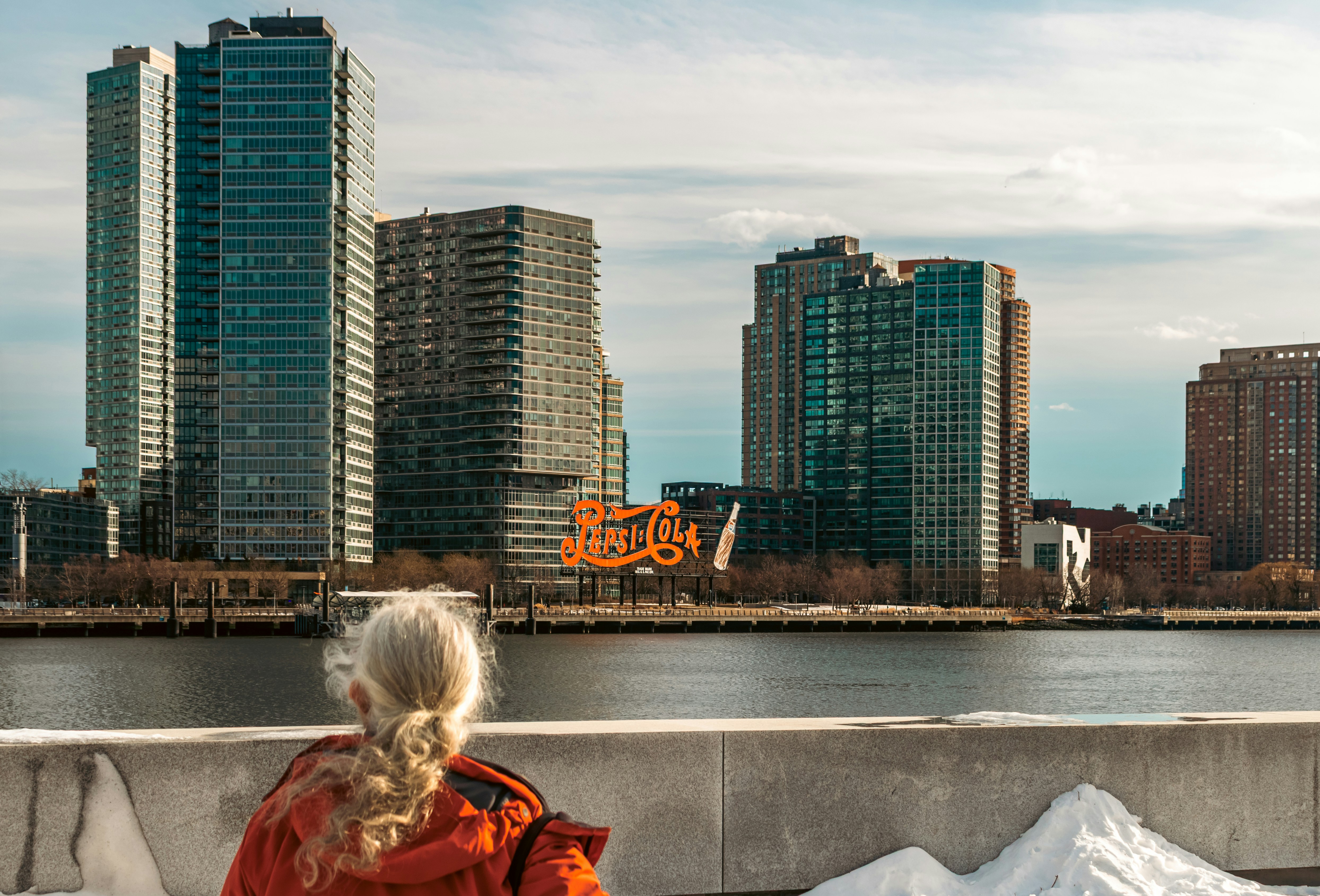 Cityscape by the River: Snow, Neon, and a Child’s View