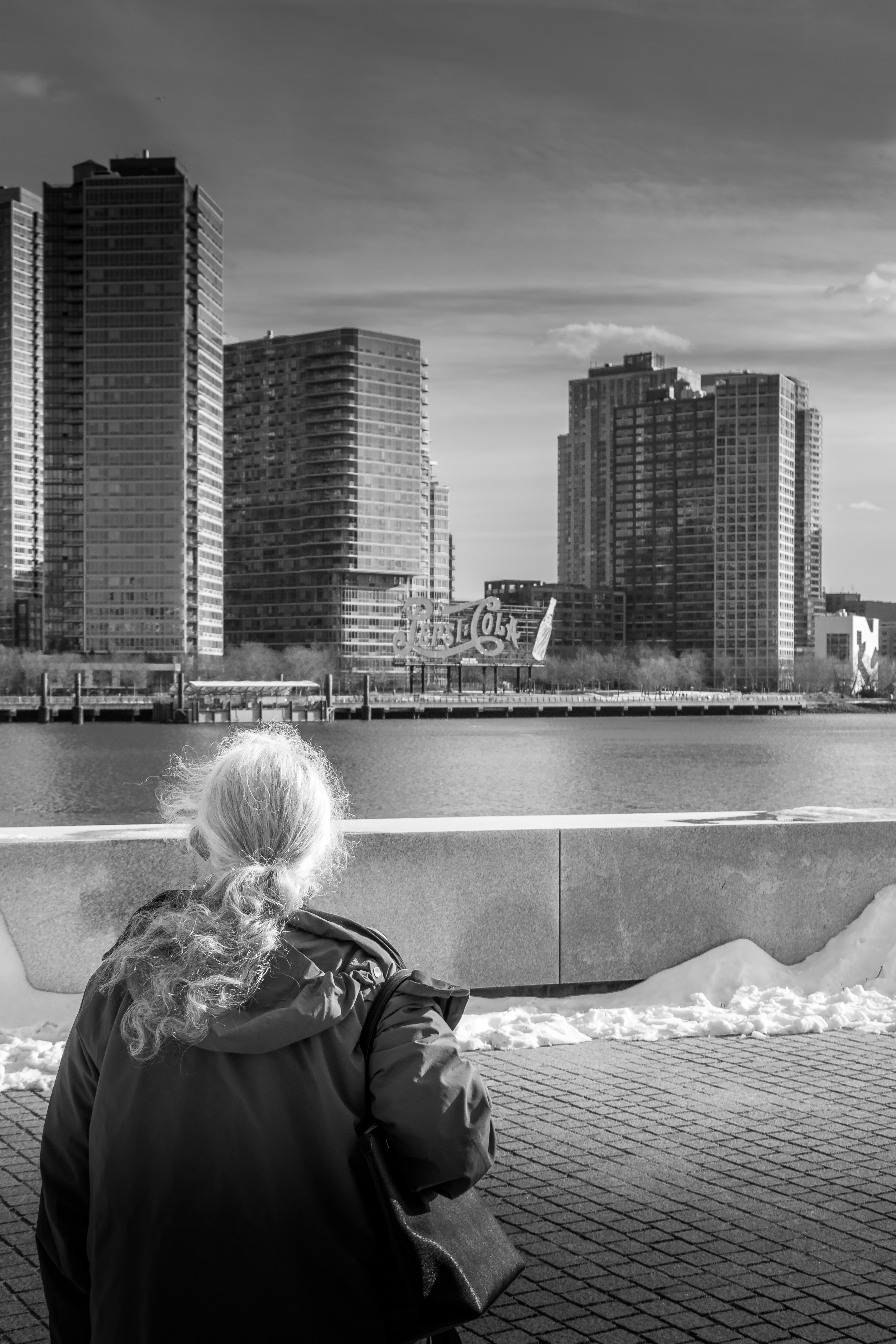 Silhouette of a Observer by the Waterfront Promenade