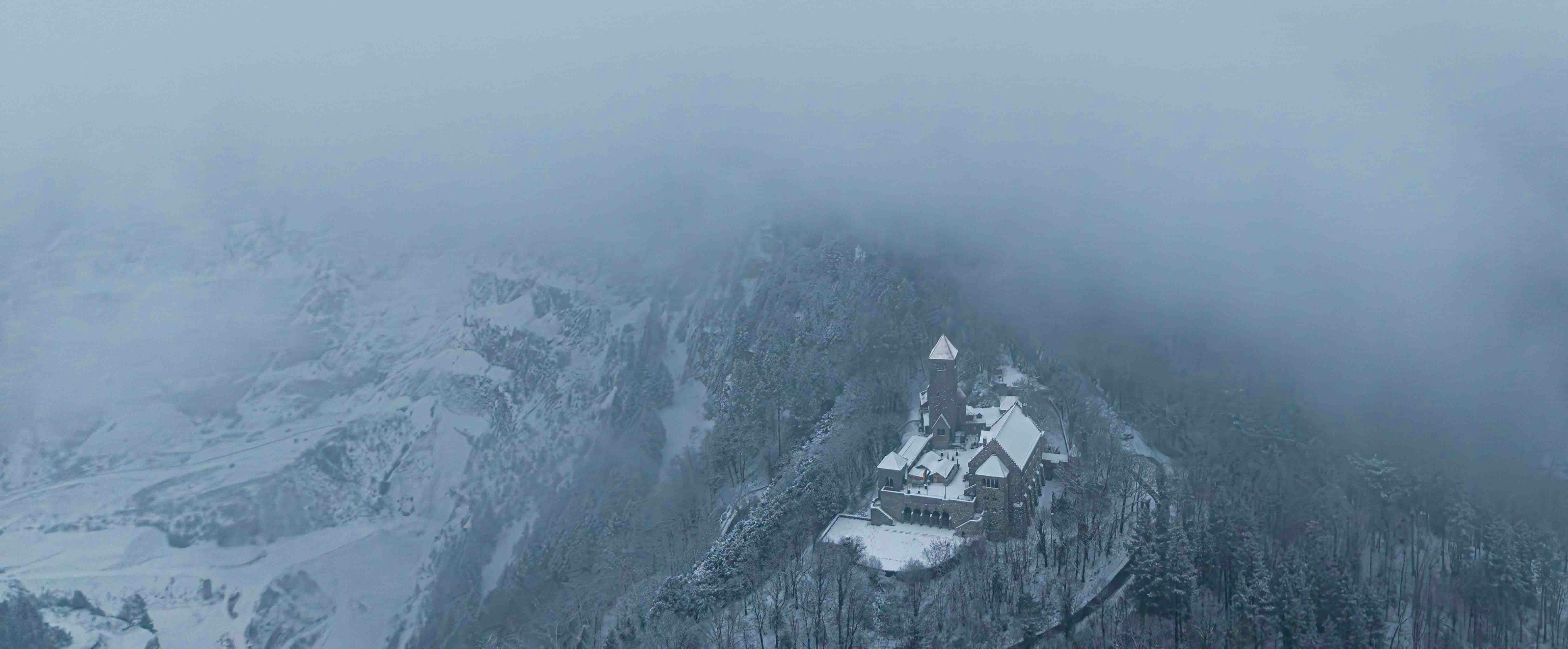 Snowbound Bastion Beneath Lingering Clouds