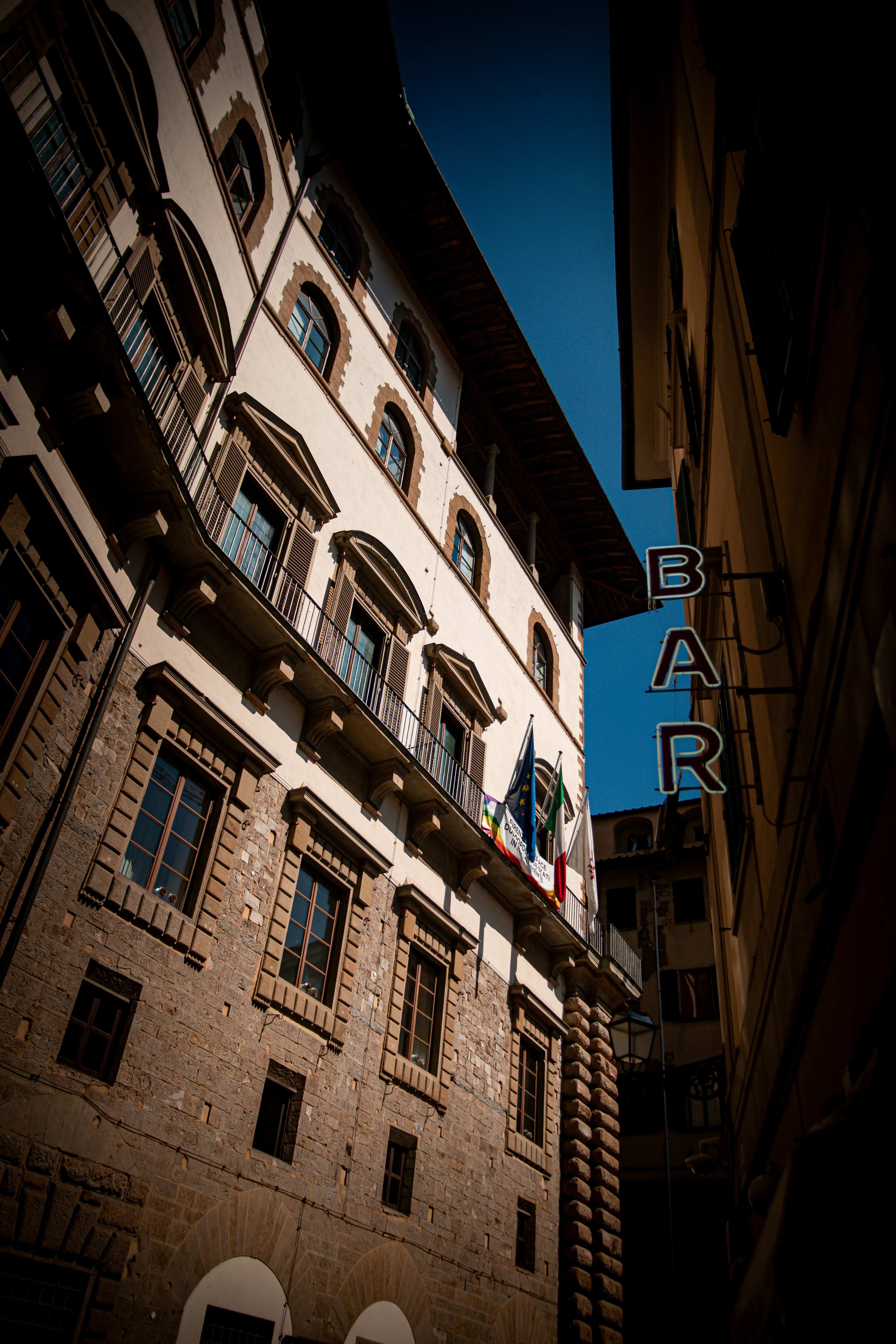 Neon Sign Over a Narrow Italian Street