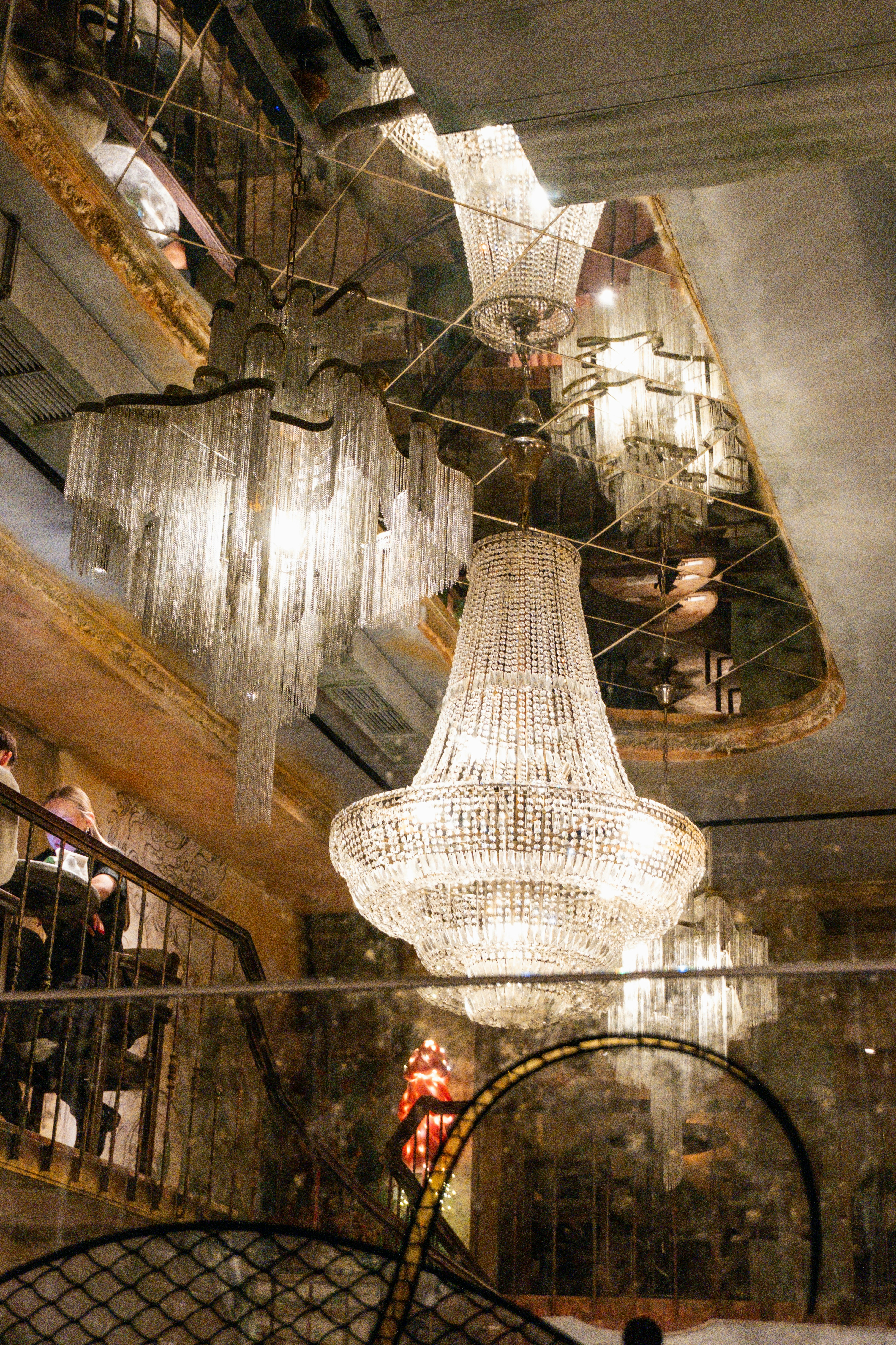 Crystal Cascade: An Opulent chandelier parades across a mirrored loft