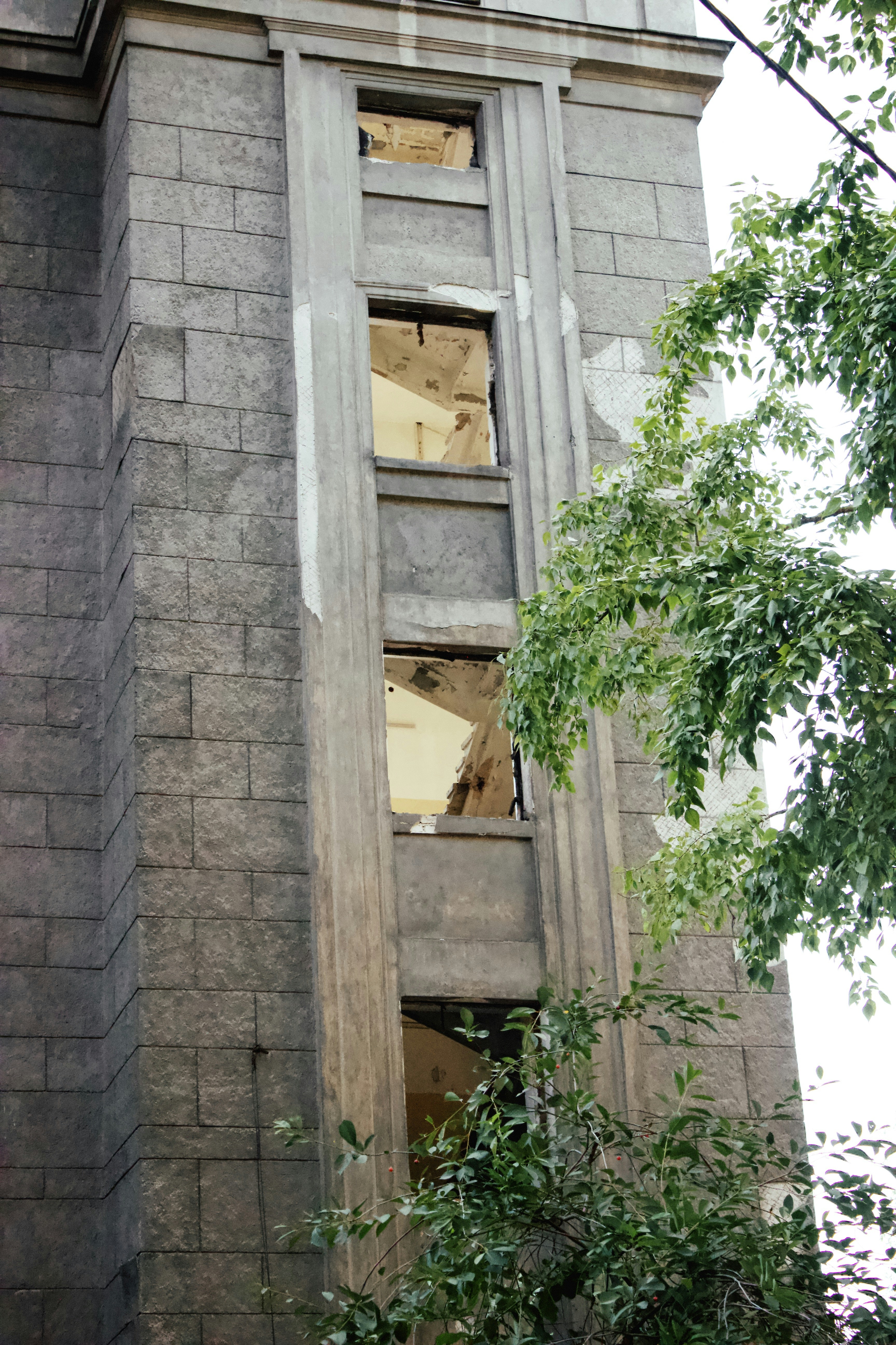 Vertical ruin: daylight through a decaying tower of stone