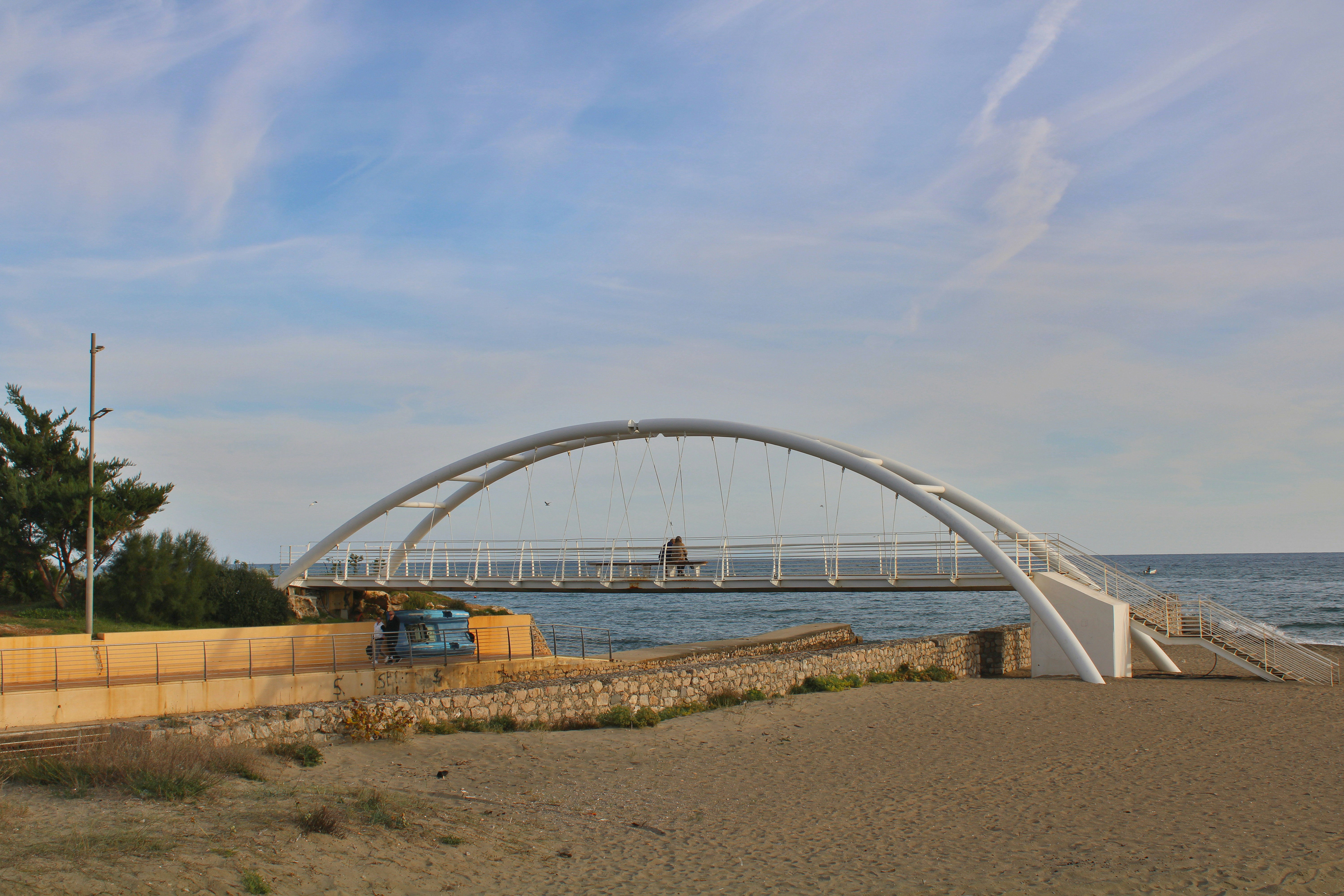 Arching Bridge by the Sea: Quiet Day at the Beach