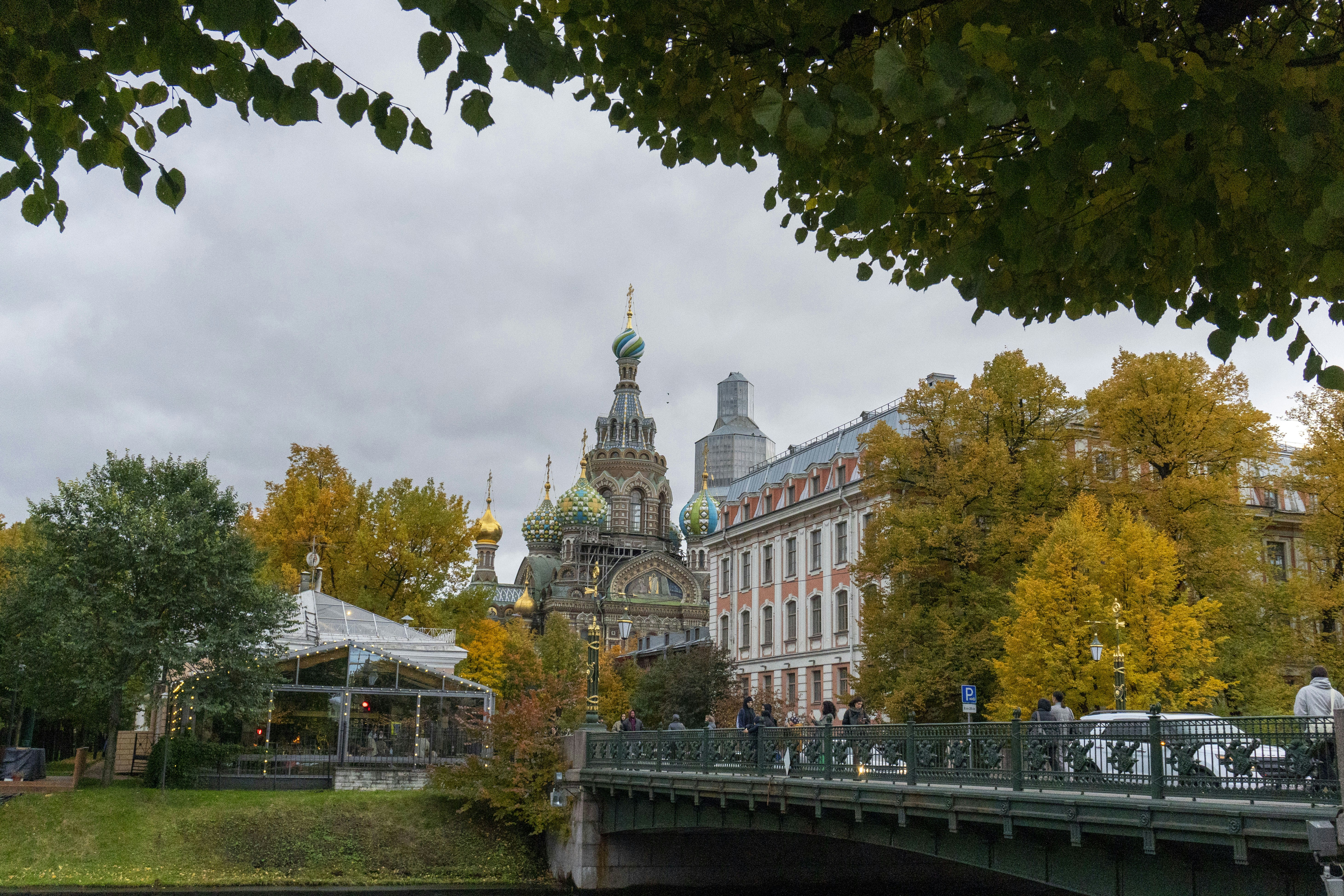 Autumnmosaic: Golden Foliage Over a European City Bridge