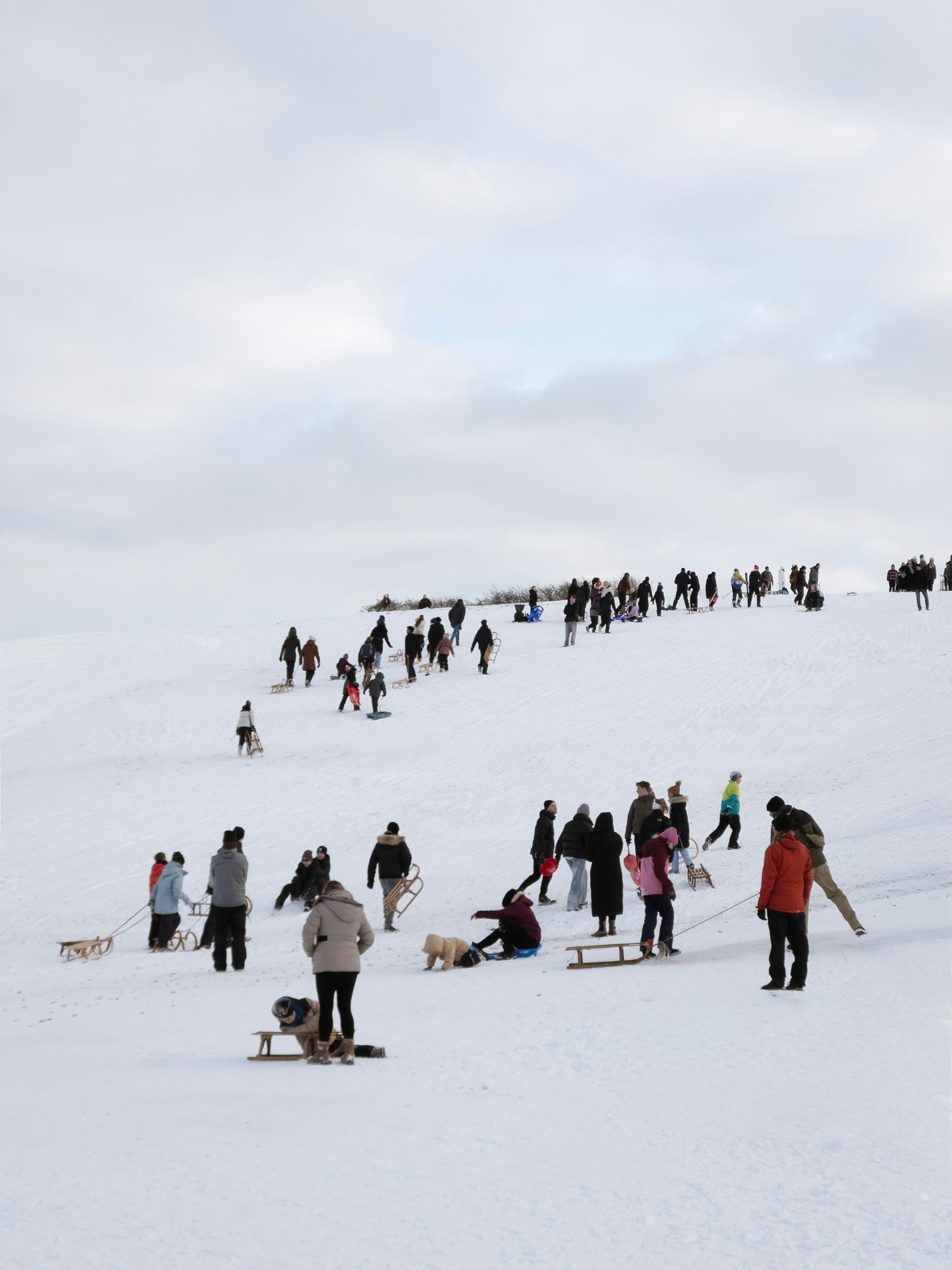 Snowfield Parade: People Trekking up a Gentle Hill