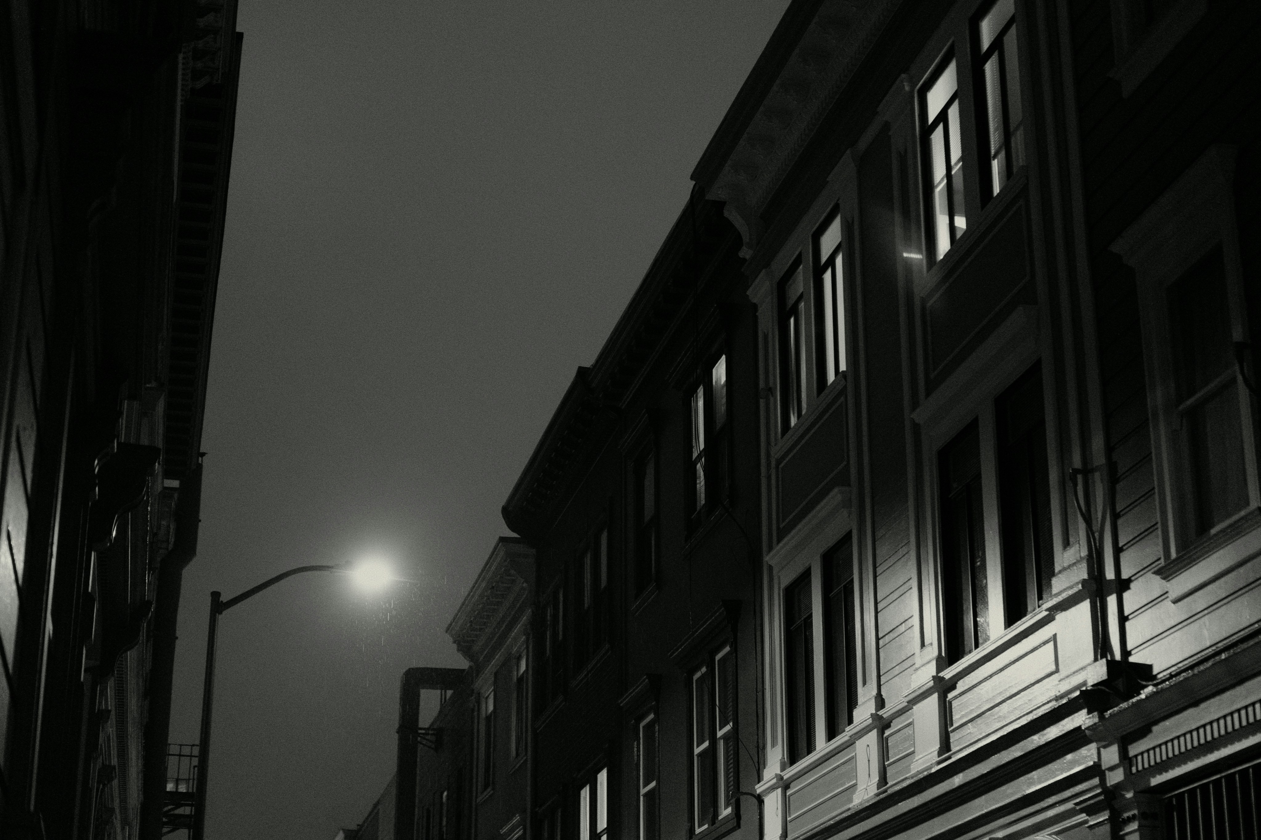 Midnight Lane: A Quiet Street Beneath Streetlamp Glow