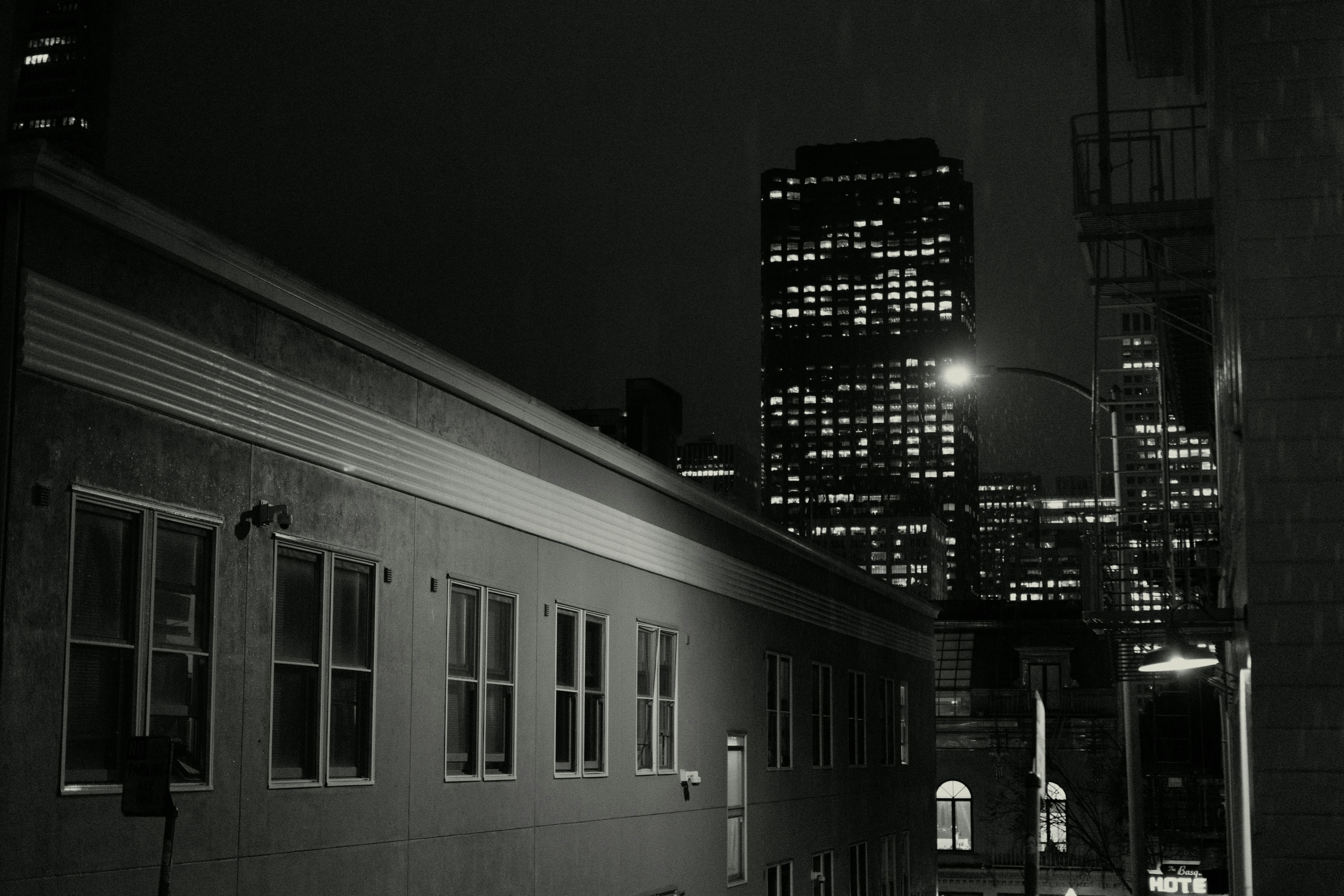 Night in the Shadowed Alley: City Lights Behind a Quiet Warehouse
