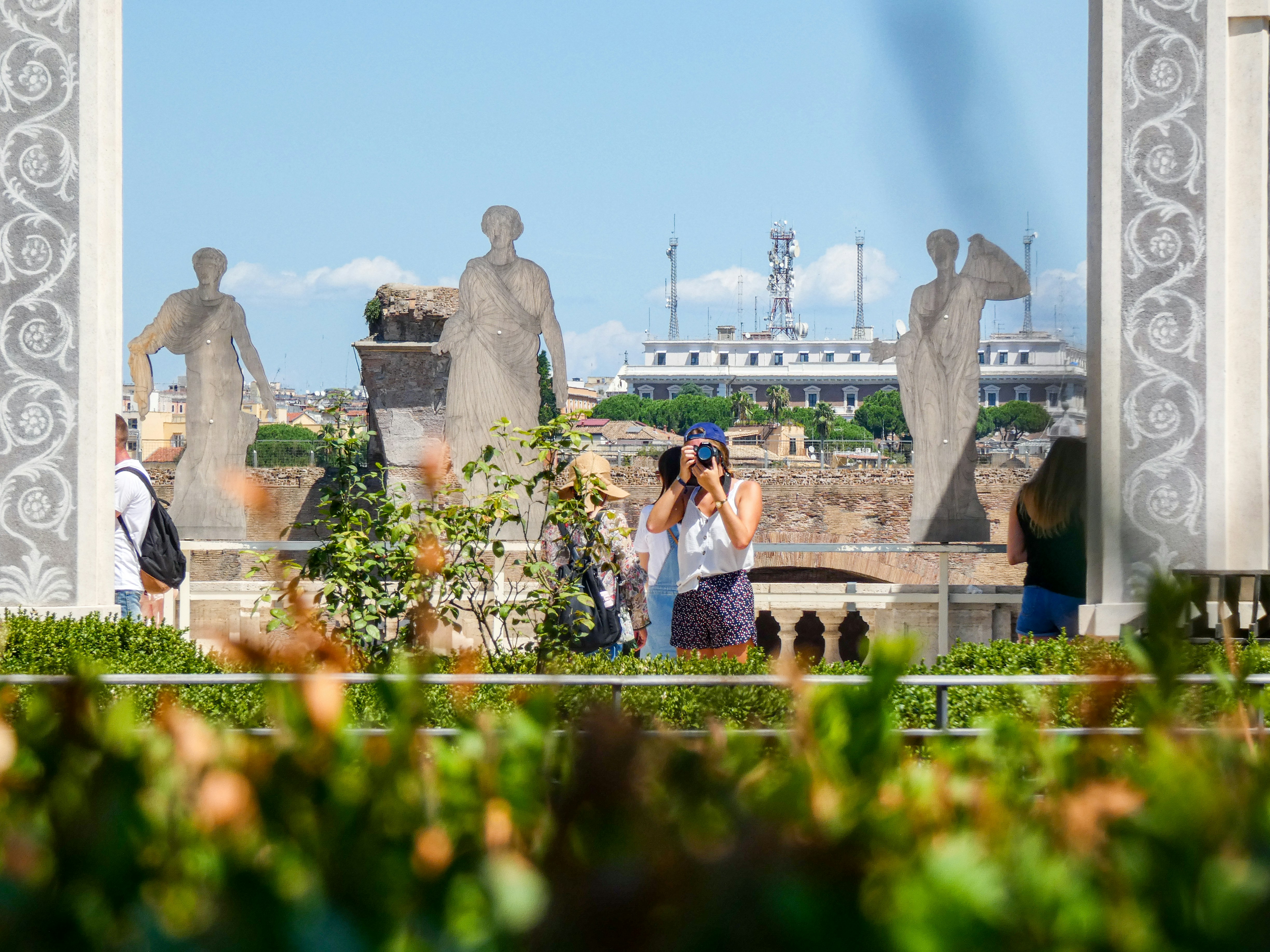 Museum Terrace Portrait: The Photographer in Focus Among Statues and Turrets
