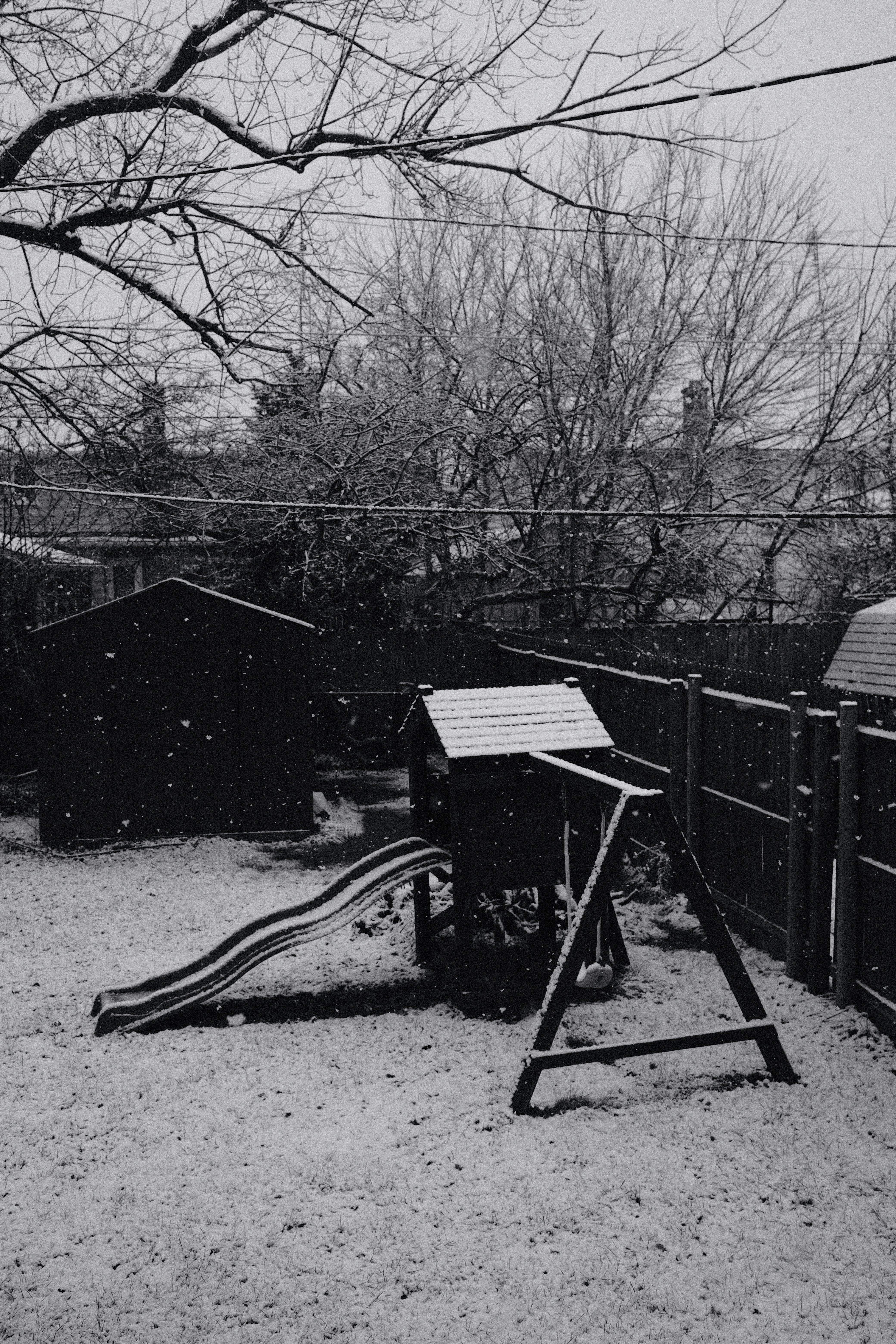 Winter Quiet: Snowfall Over a Backyard Playground