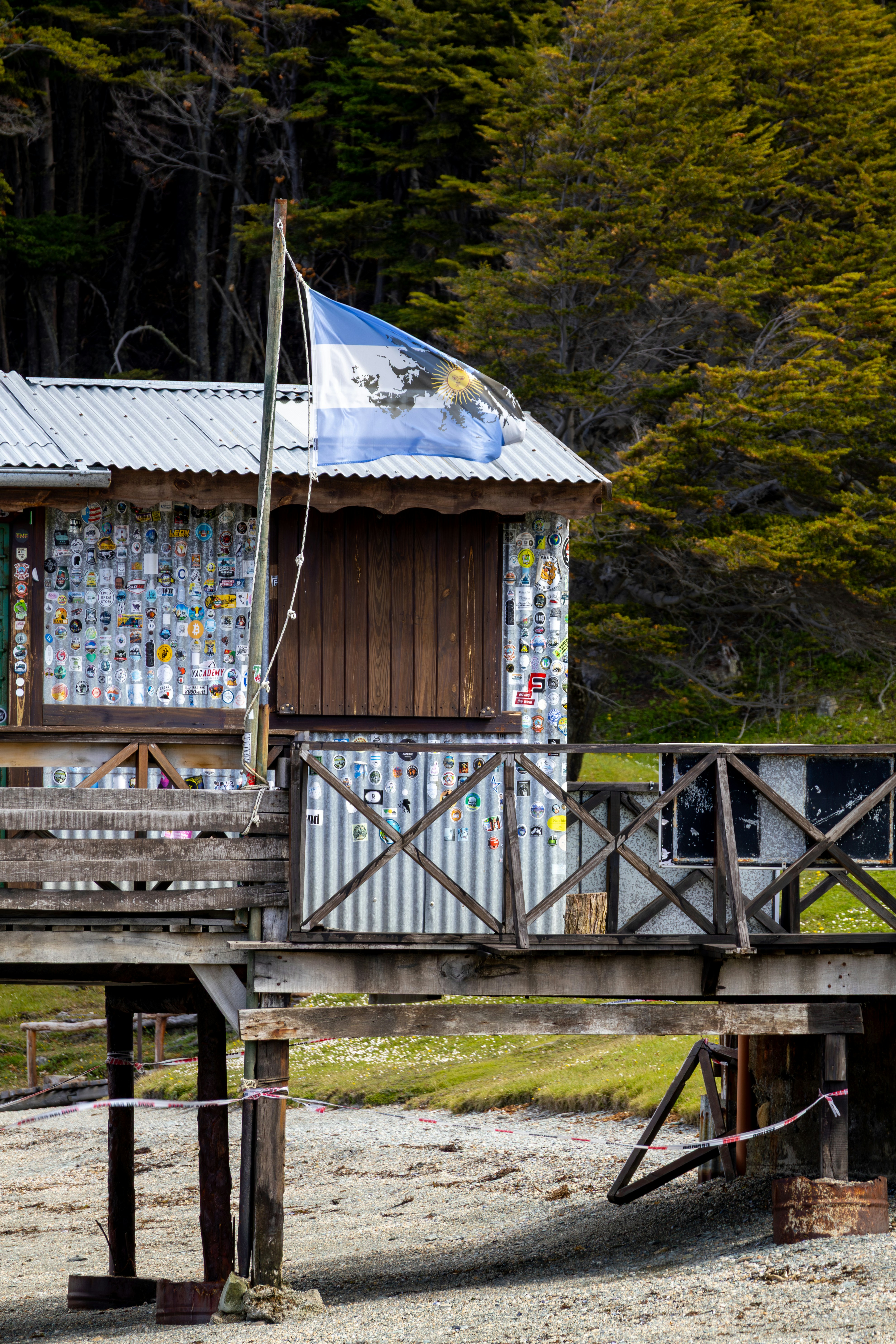 Flag Bunting Above a Weathered Lakeside Cabin