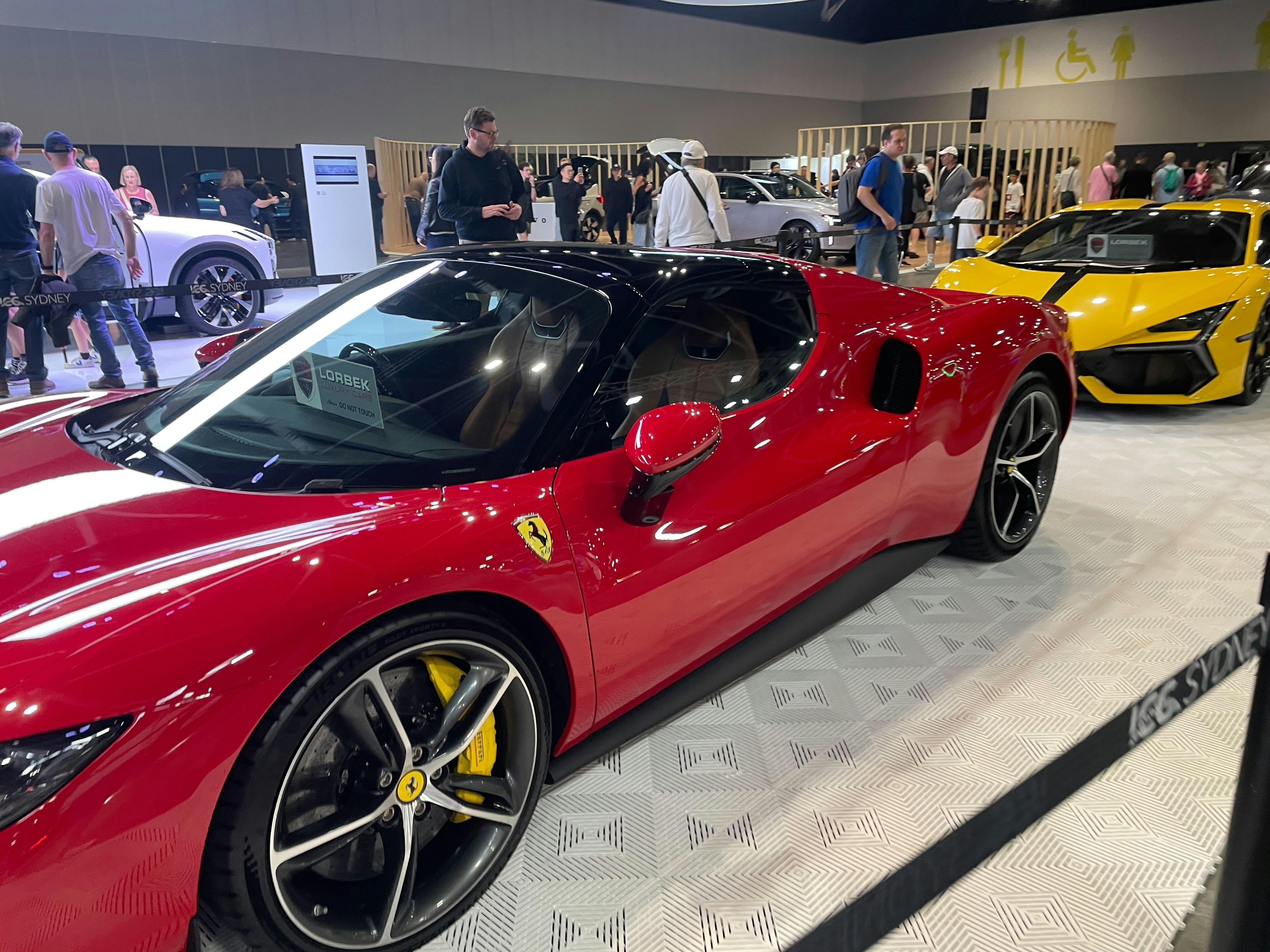 Scarlet Ferrari on Display: Glide of Red in a Modern Showroom