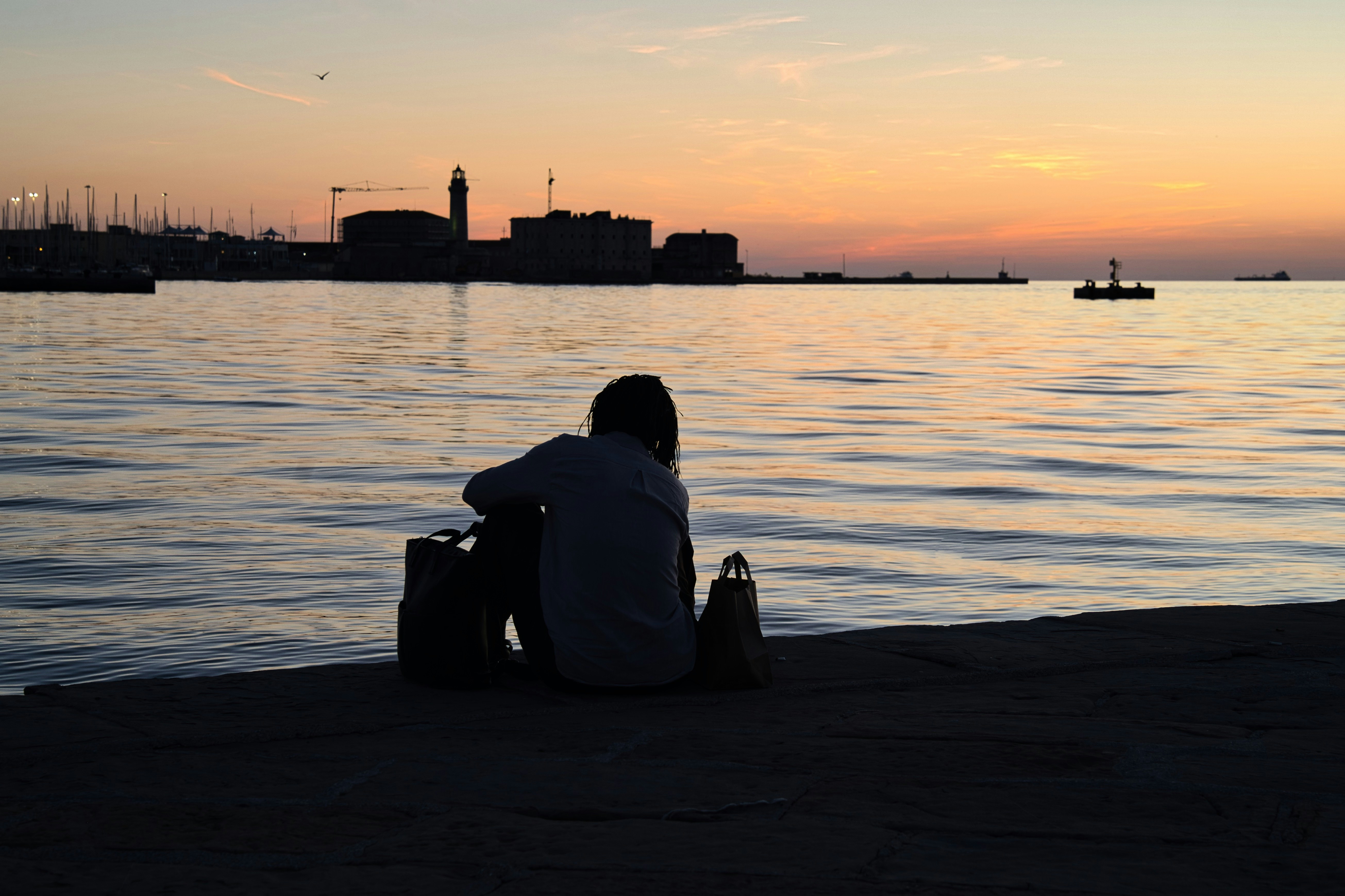 Sunset by the Pier: A Quiet Moment with a Seated Figure
