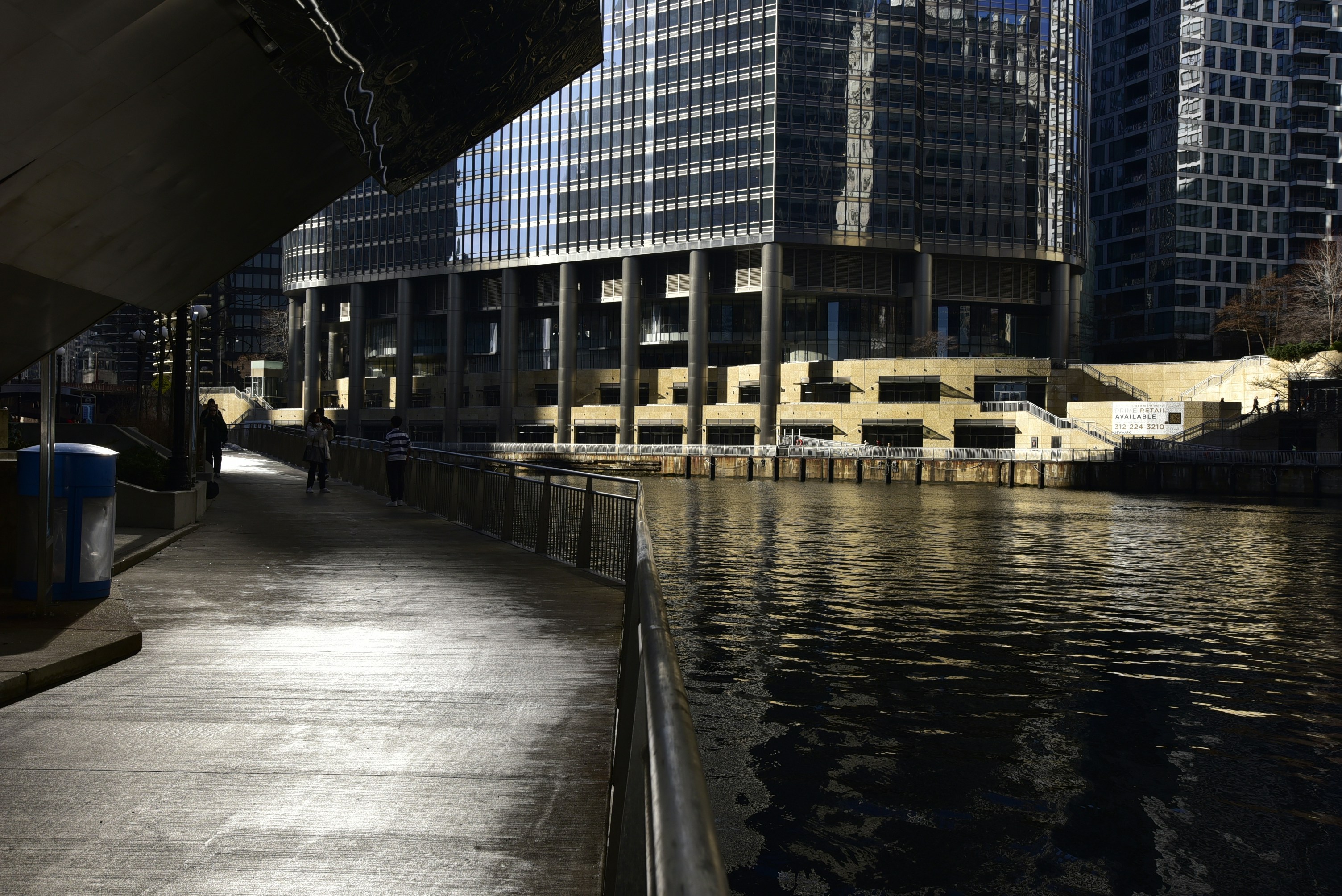 Riverwalk Silhouettes: City Edge by the Water
