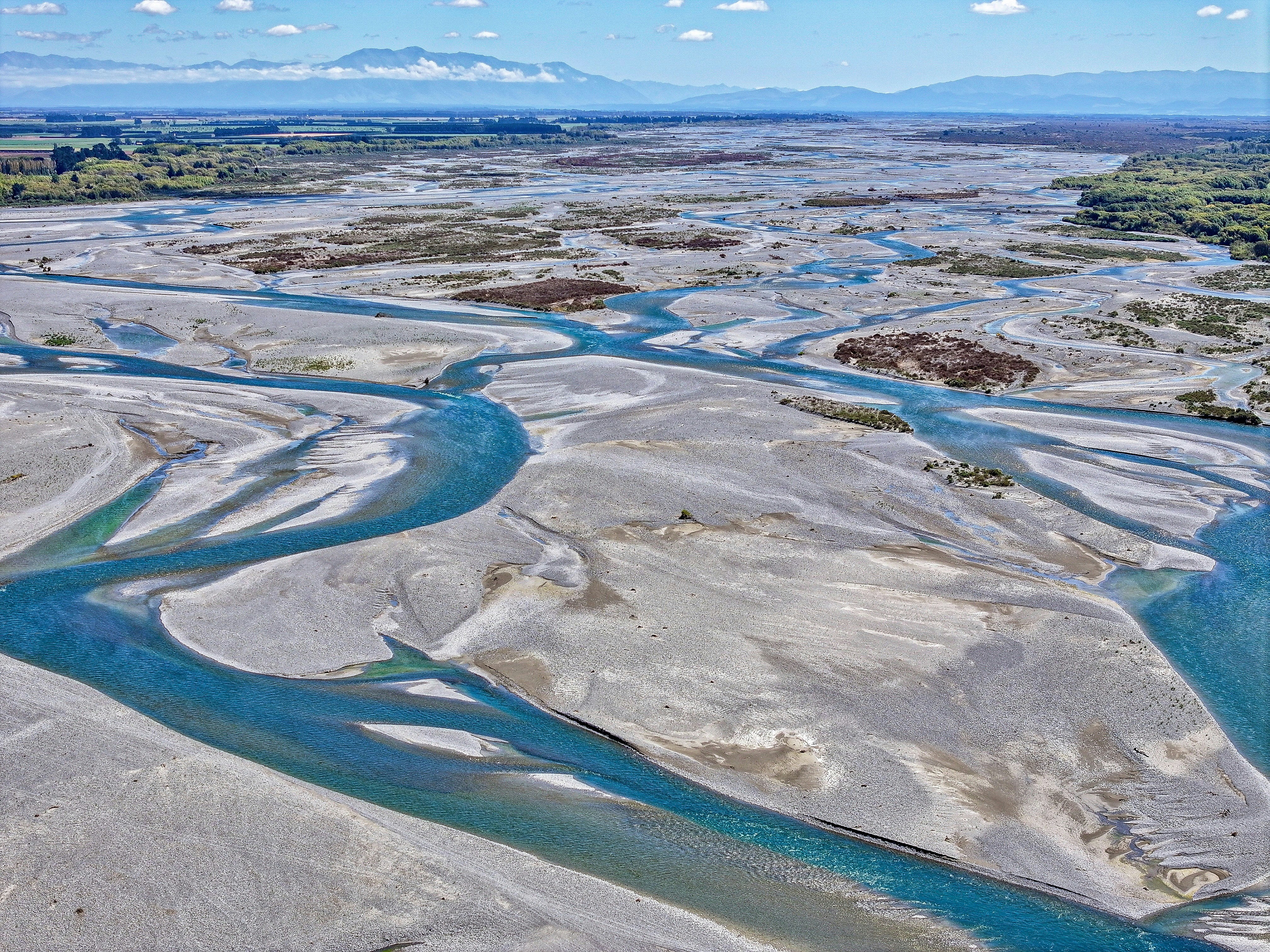 Braided river system with turquoise water and sandbanks.