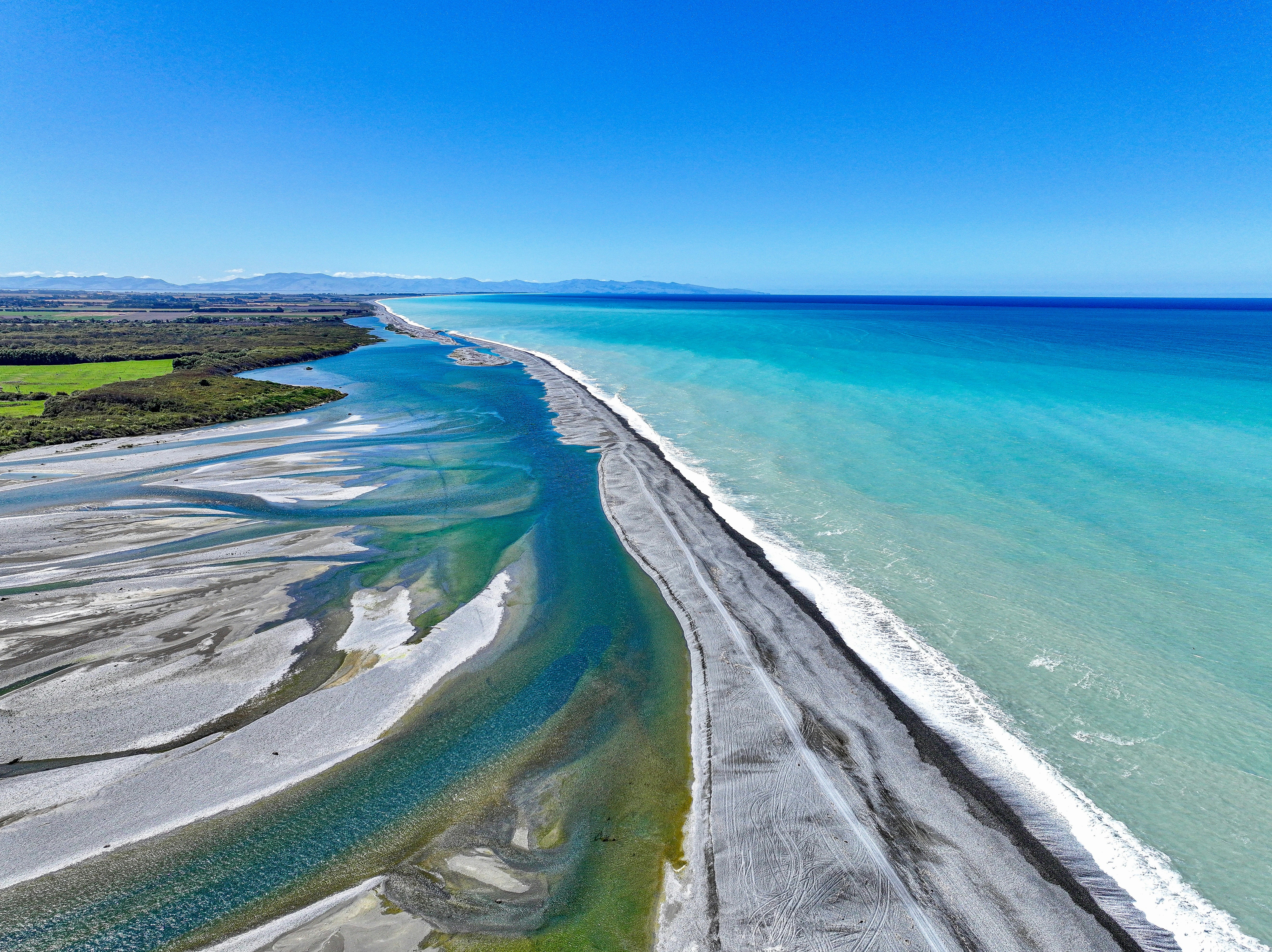A Quiet Shallow Divide: Turquoise Waters Meeting a Pale Shore