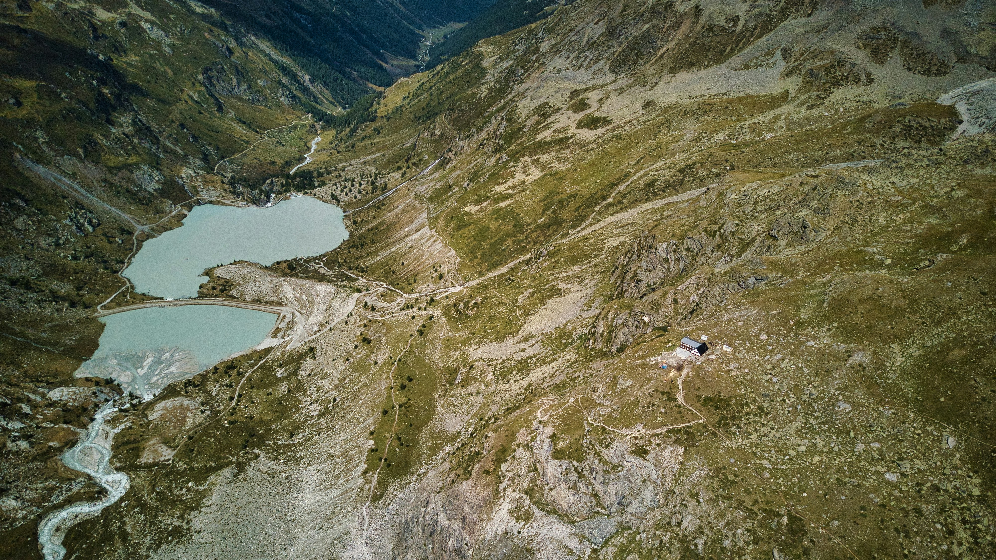 Glacial valley enshrined by jagged ridges: a lone traveler threads a rocky pass