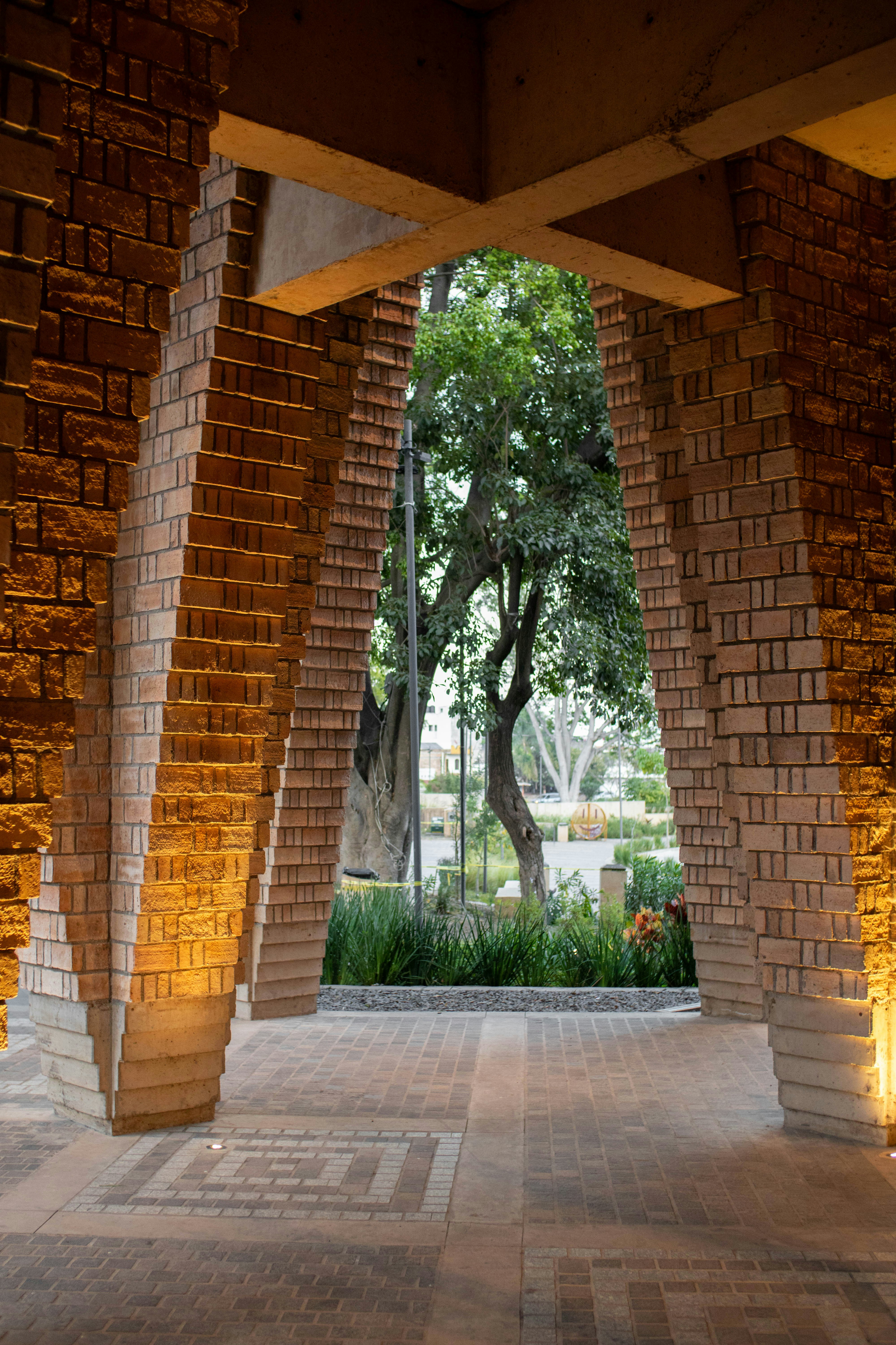 Arcade of Warm Light: A Corridor Framing a Quiet Garden