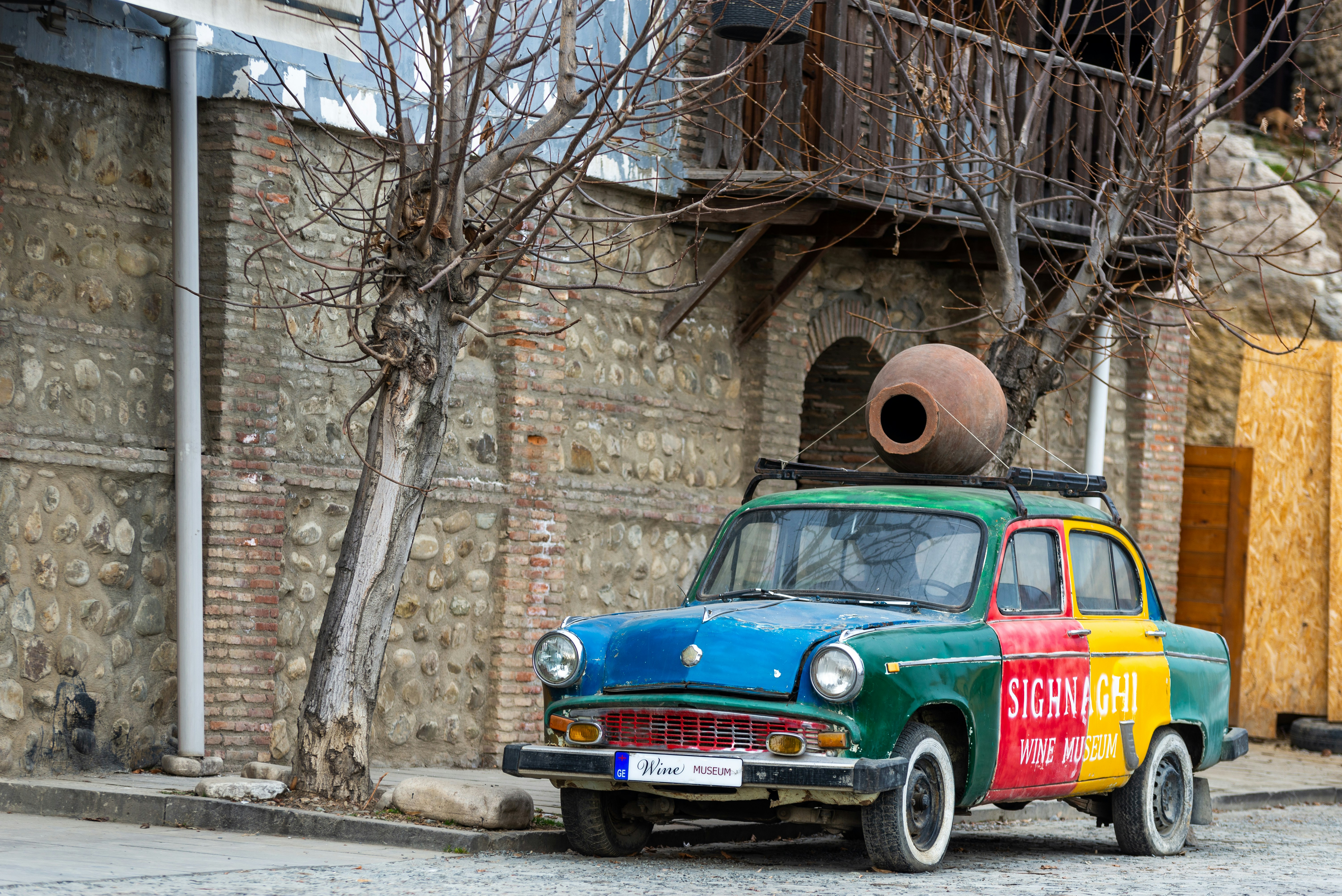 Old Roadside Chime: A Vintage Car Adorned with a Giant Vessel