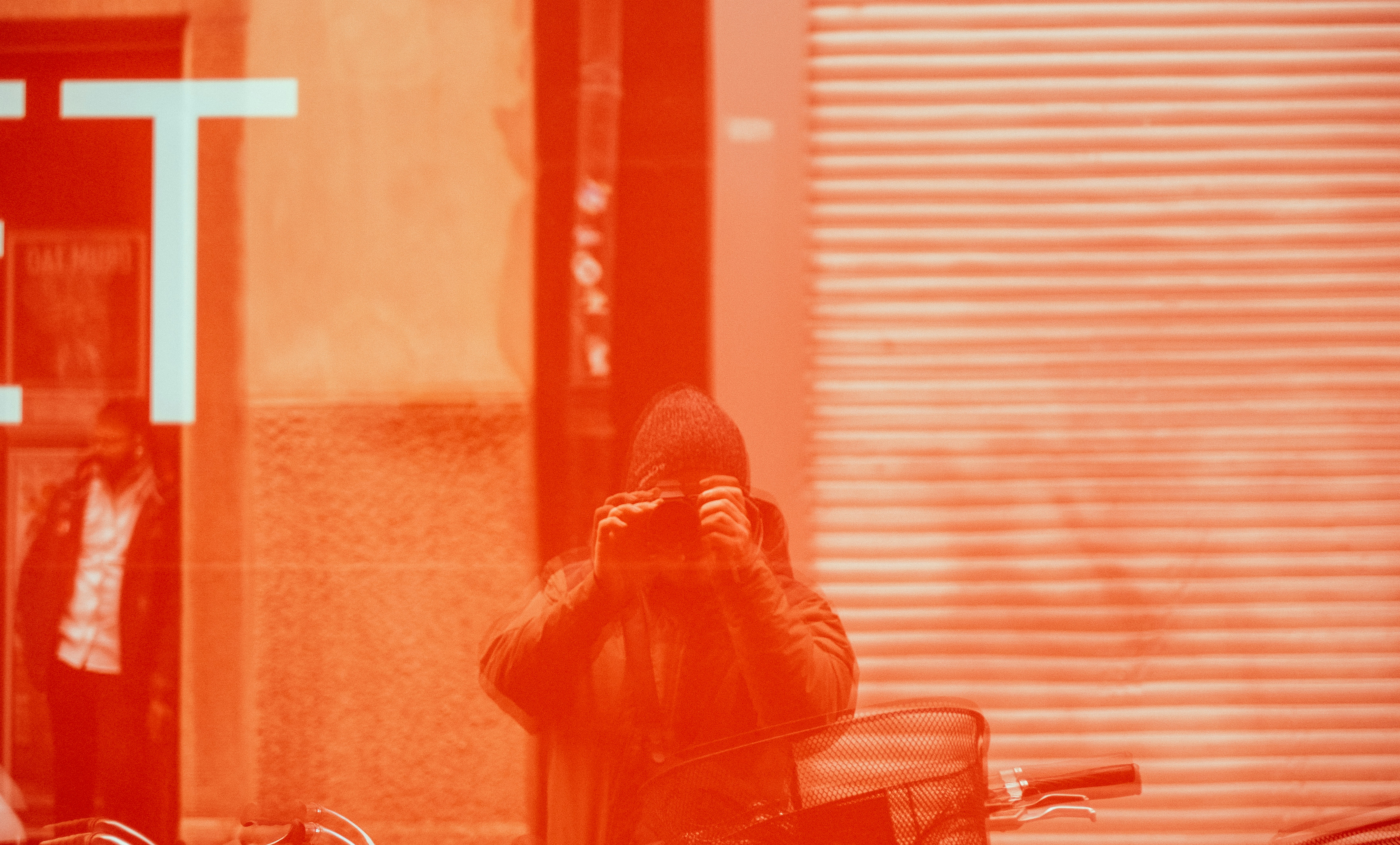 Reflective Street Portrait Behind Red Tint