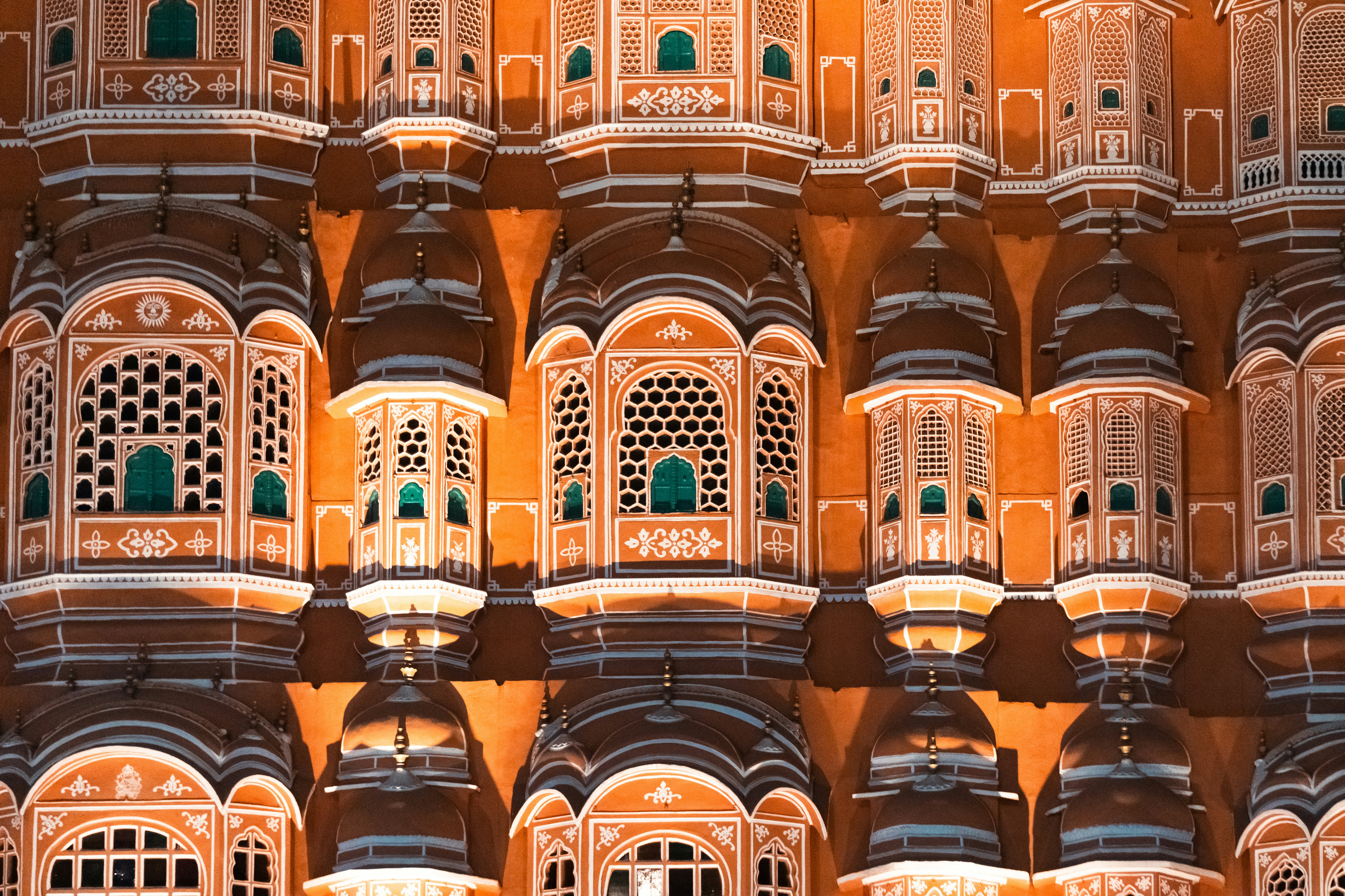 Ornate Balcony Facade: Repeating Carved Patterns in Warm Light