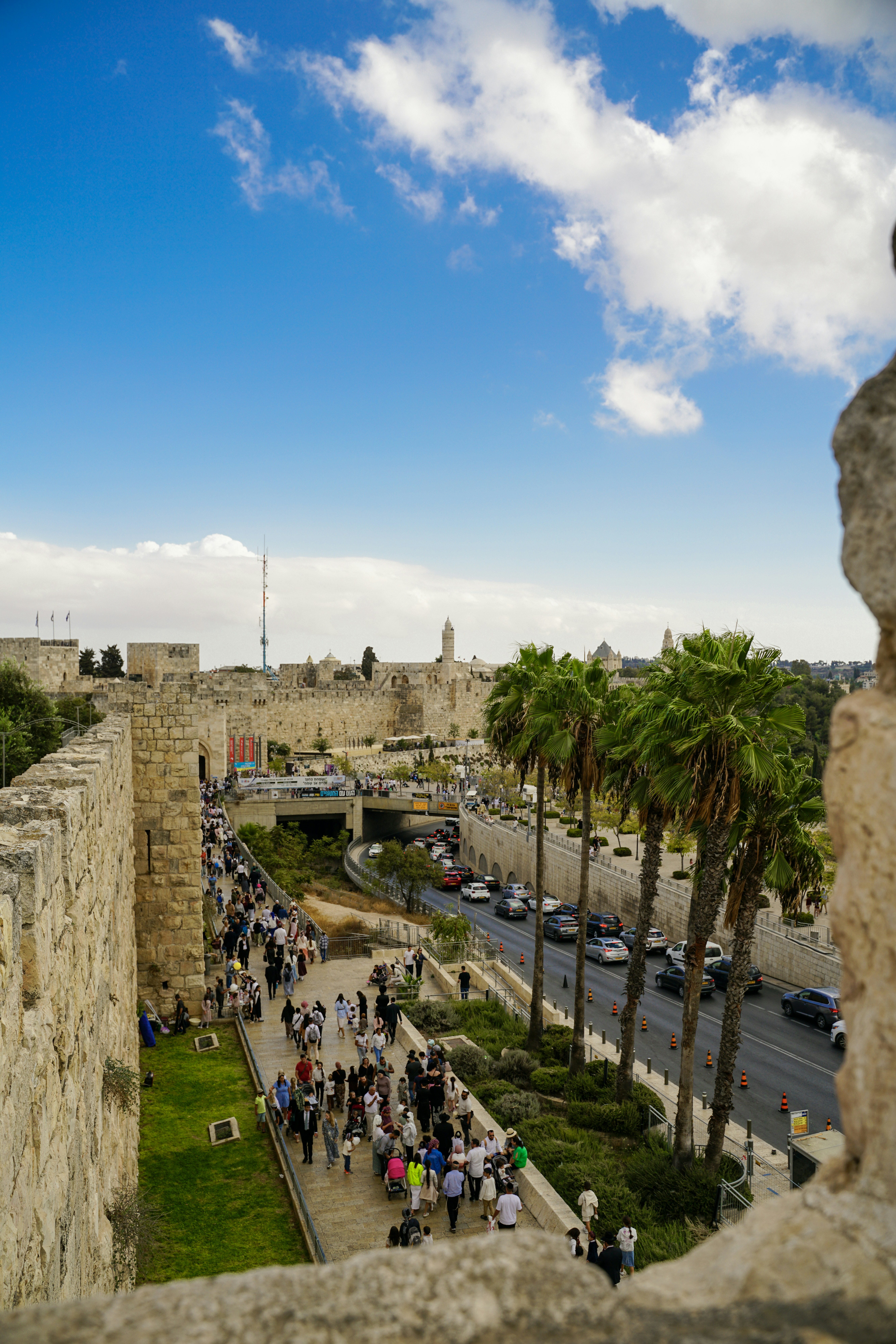 People walking along ancient city walls with palm trees photo – Free ...