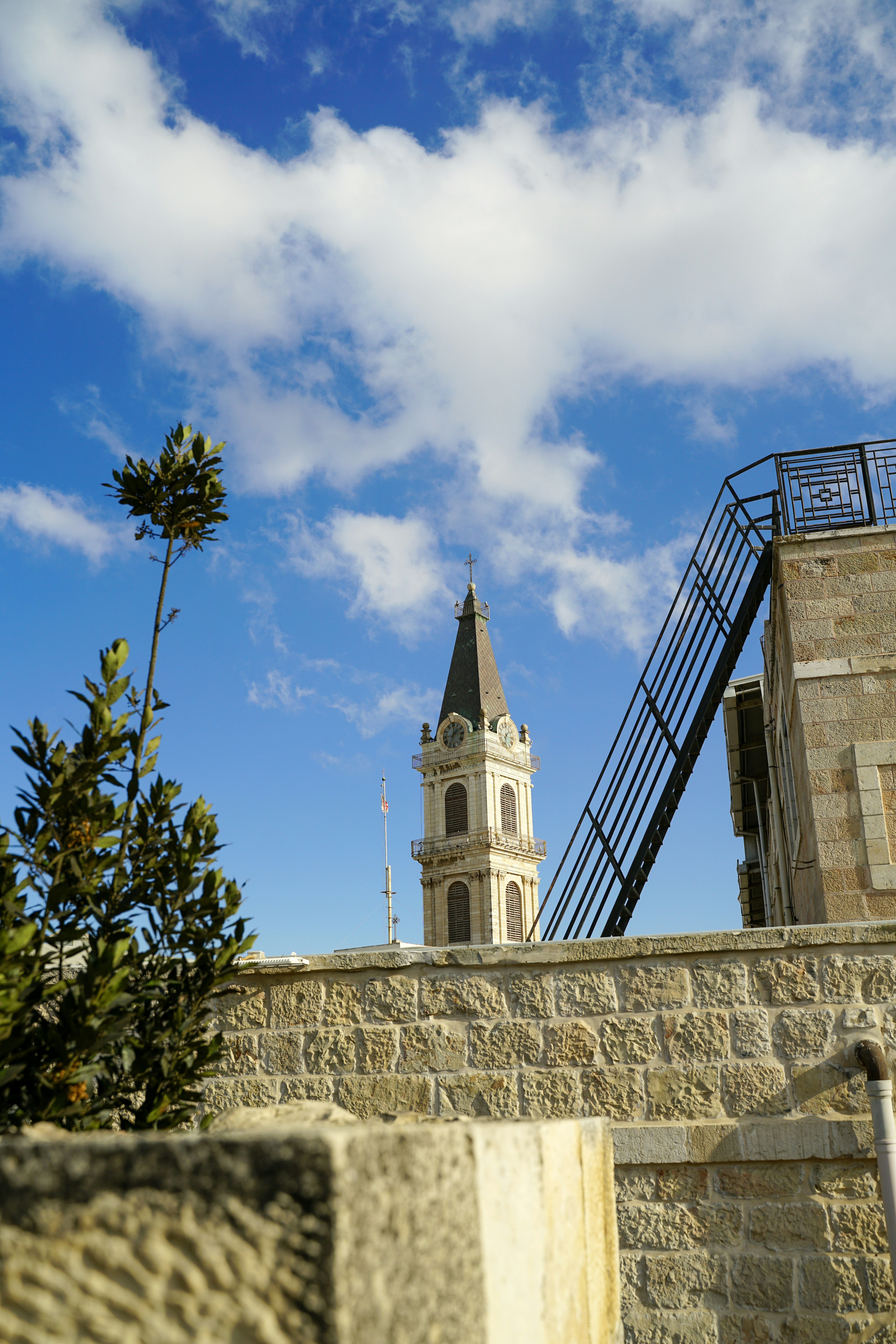 Stone Staircase and Clock Tower Under a Clear Blue Sky