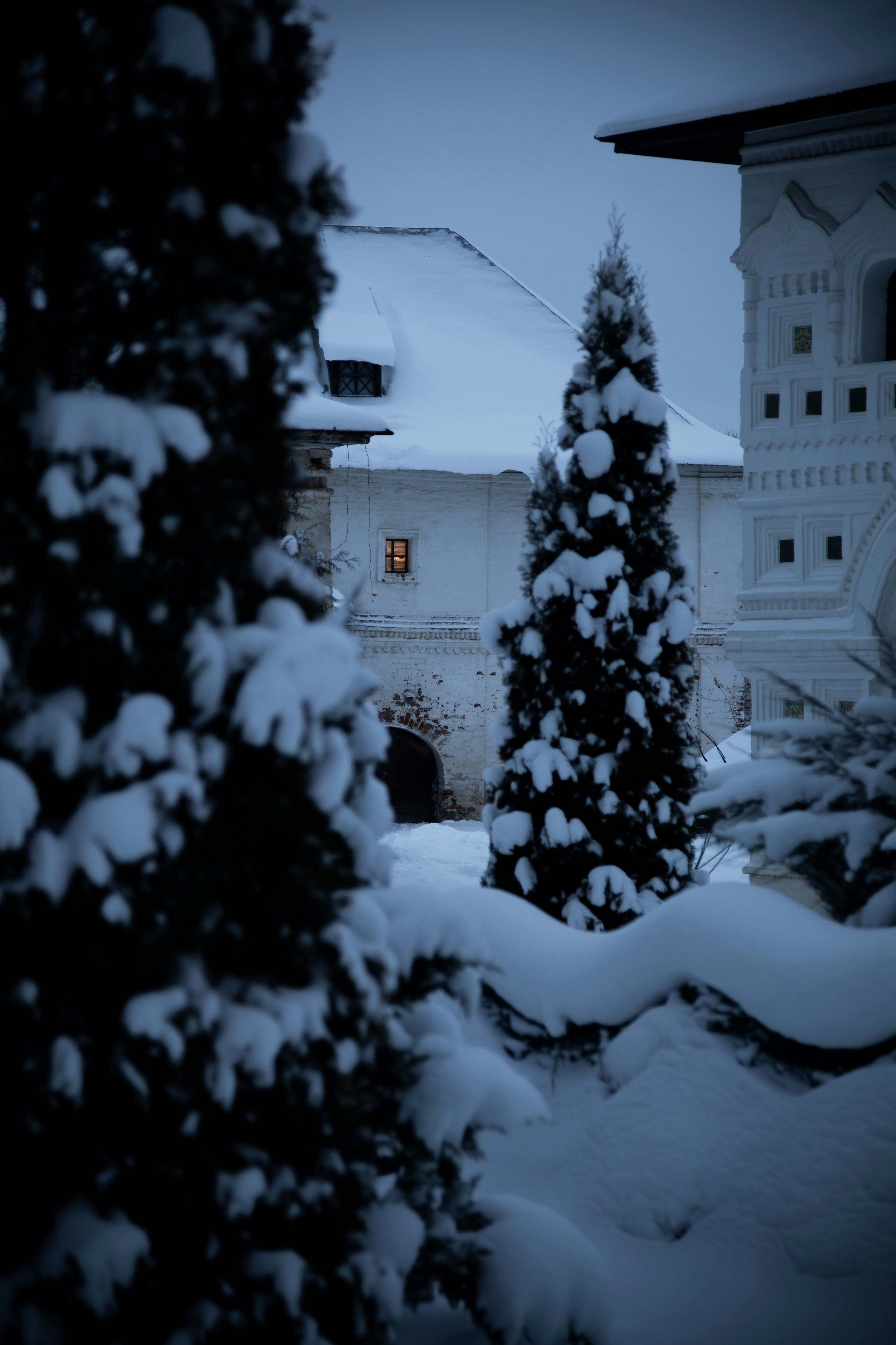 Snowbound Courtyard: Warm Light Amidst Frosted Architecture