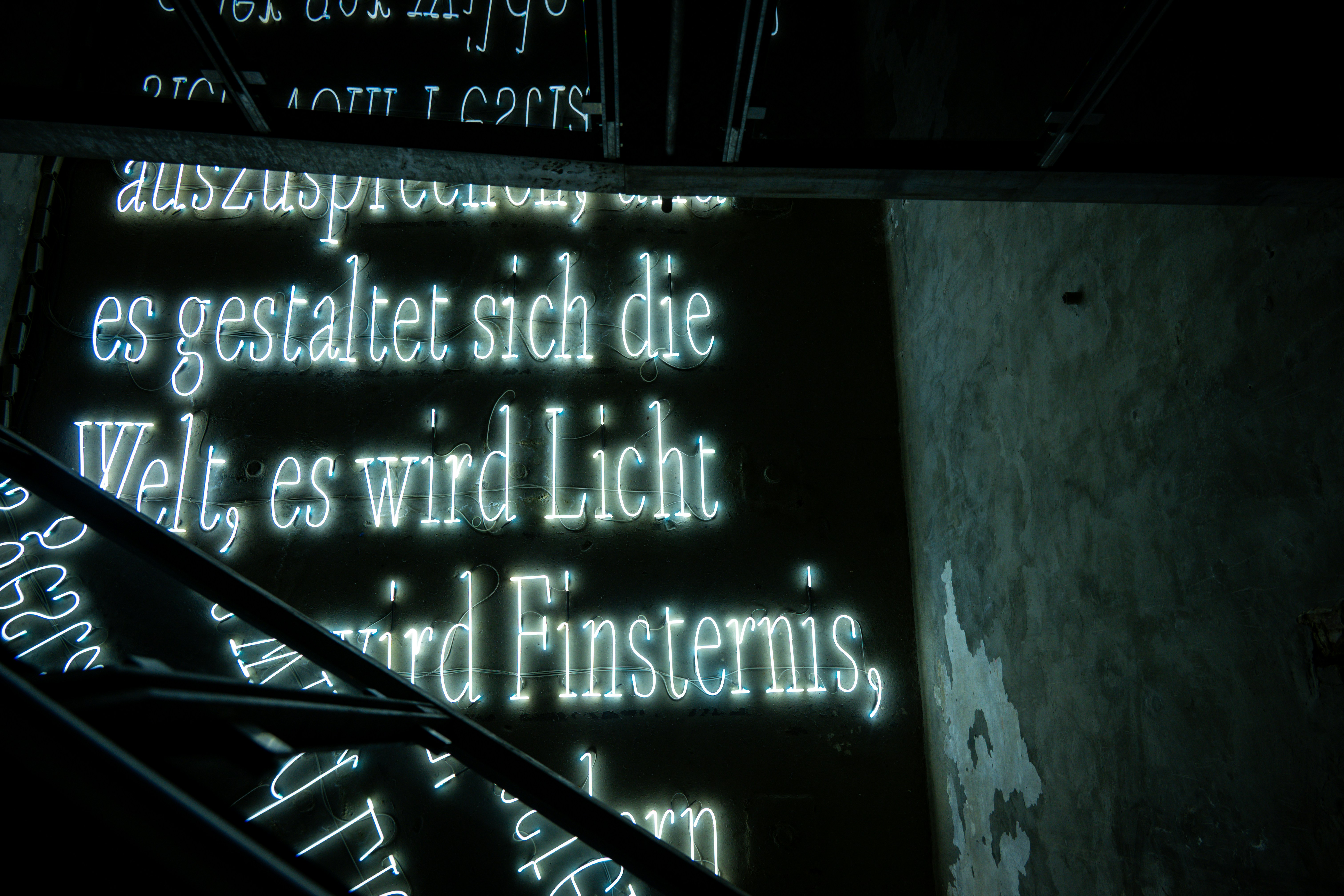 Glowing German Script Illuminates a Crumbling Wall