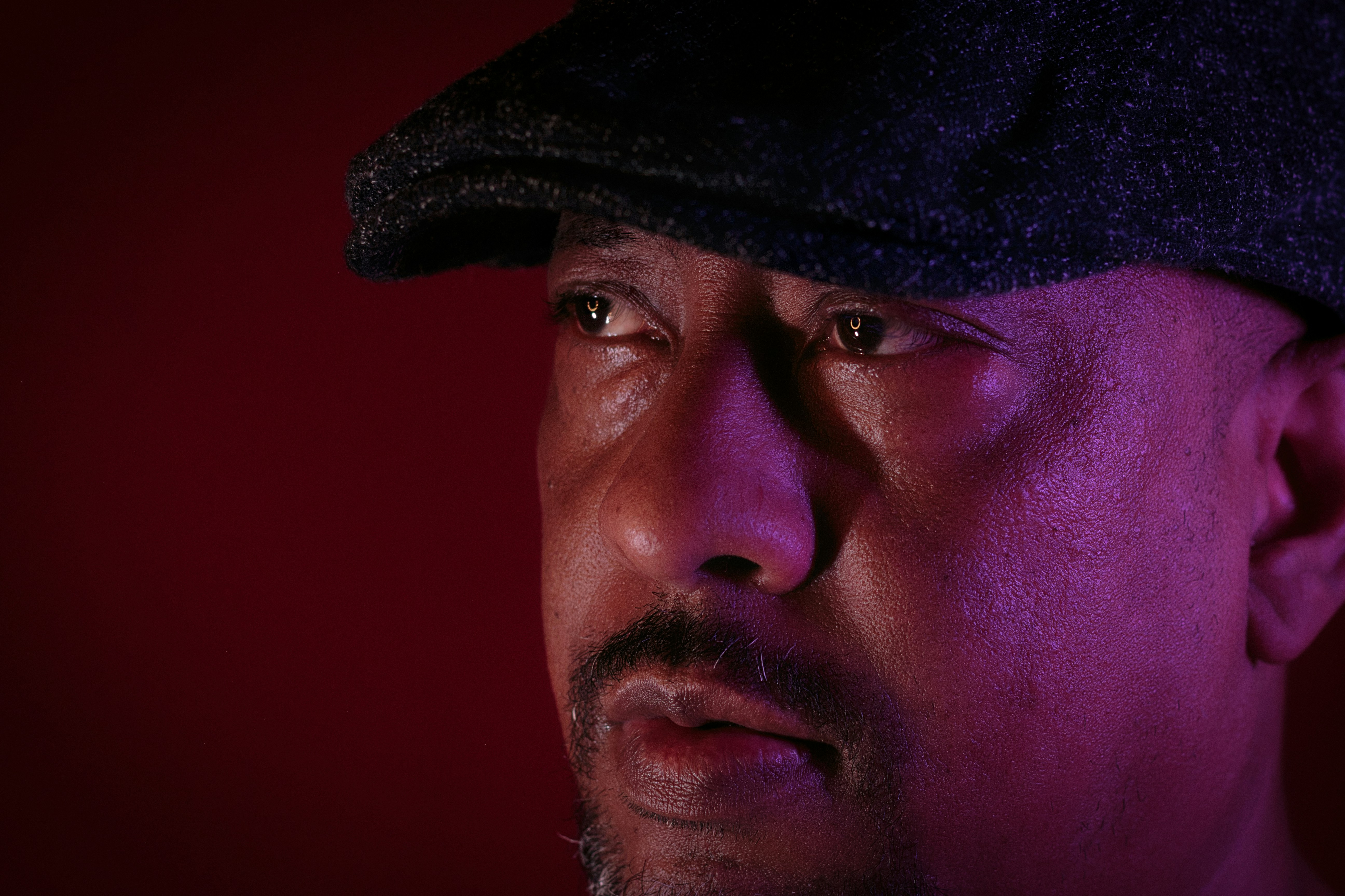 Low-Key Portrait of a Man in Colored Spotlight