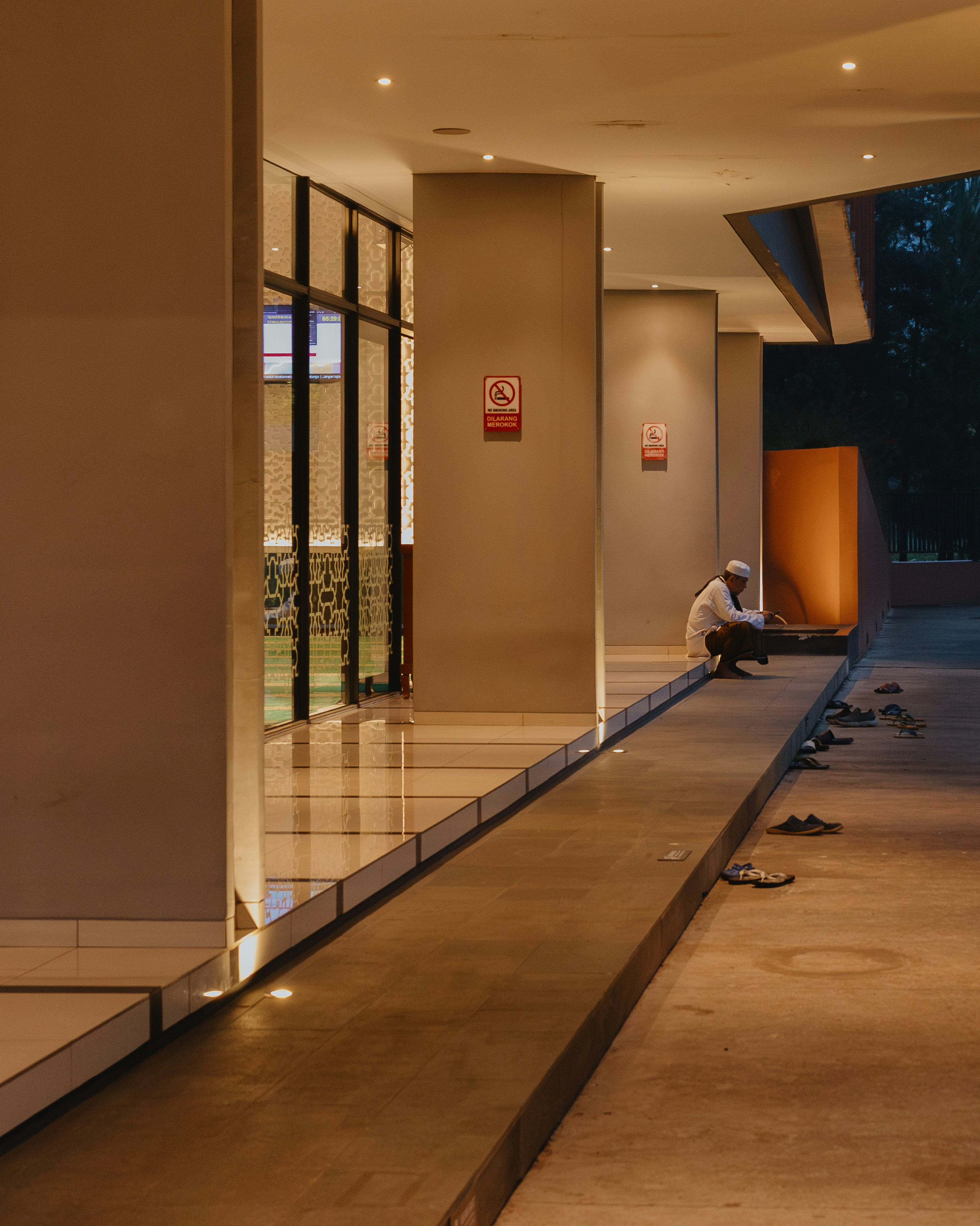 Quiet Pause by the Colonnade: Solo Figure in Evening Light