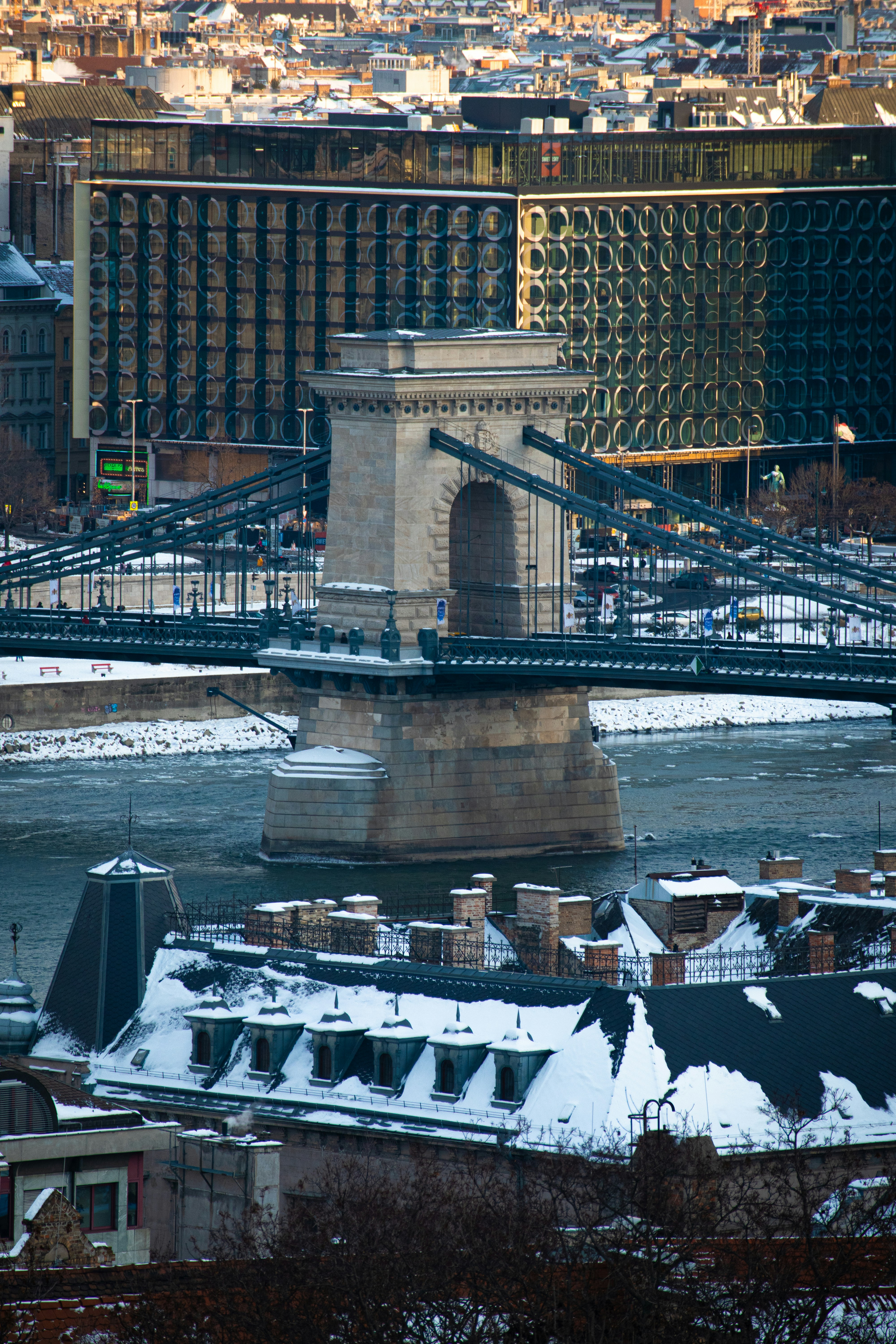 Towering Suspension in Snow: A City Bridge over Icy Waters