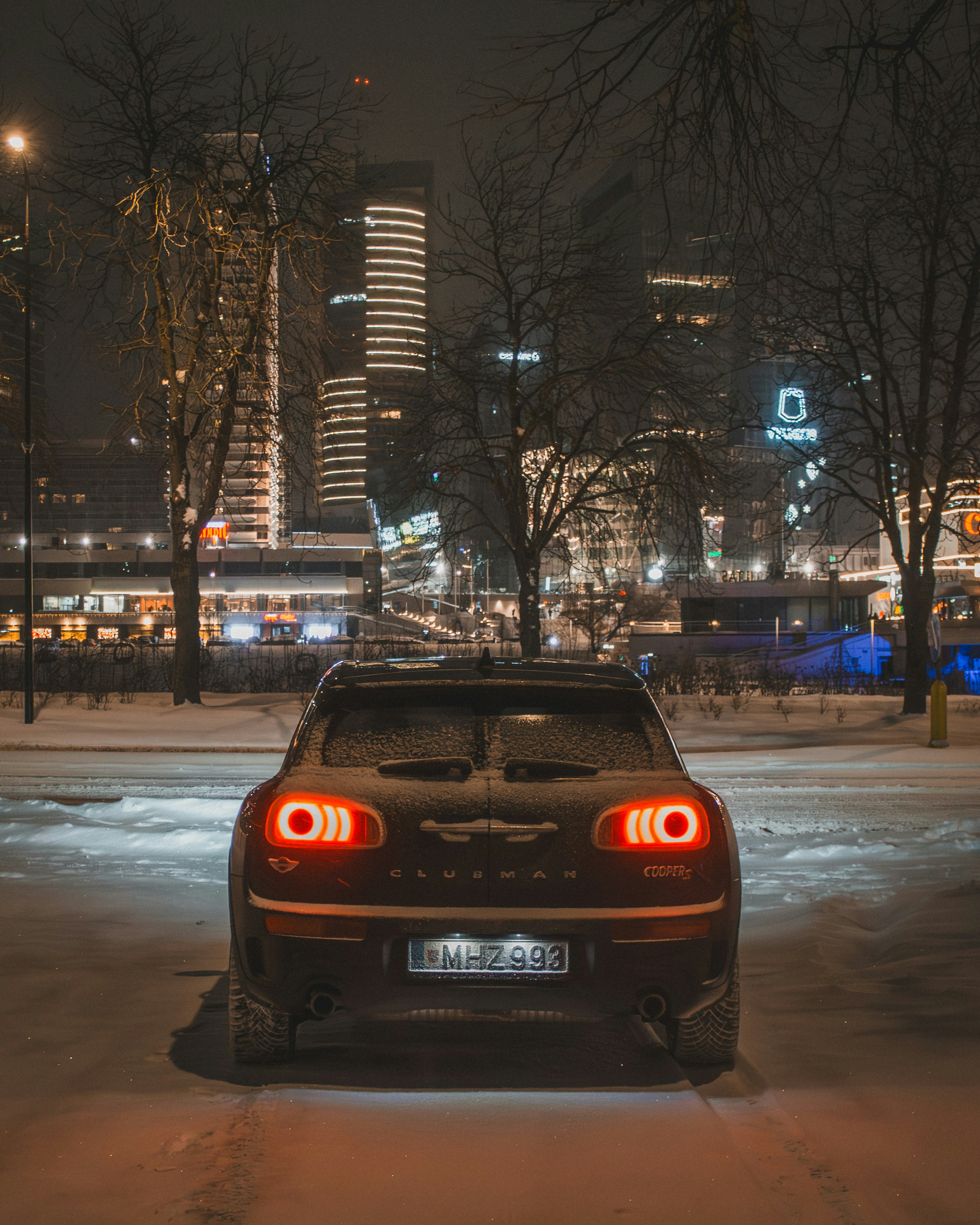 Snowy Night Rally: Tail Lights Glow Over Icy Parking