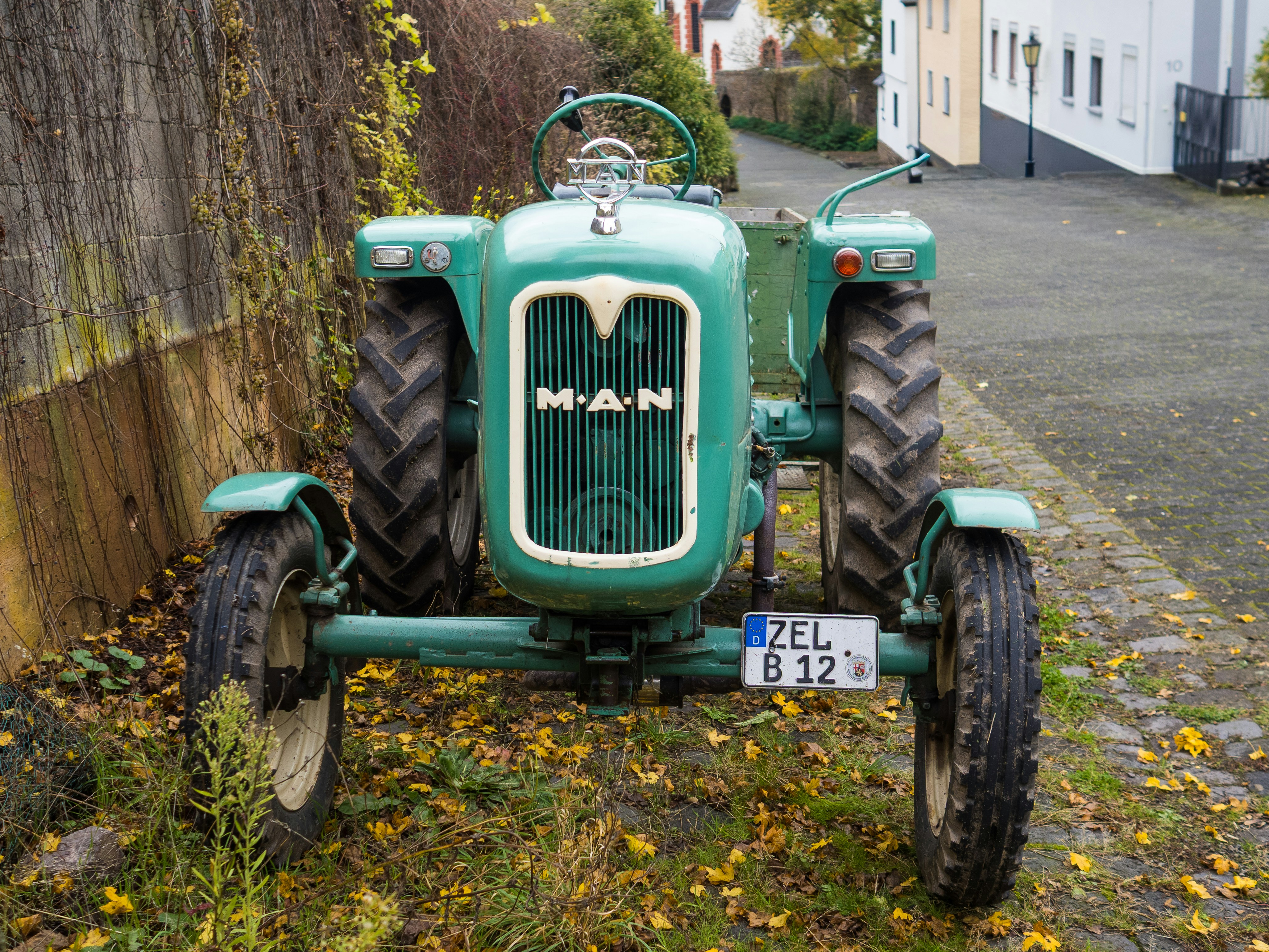 Vintage Green Tractor Waiting in the Quiet Street
