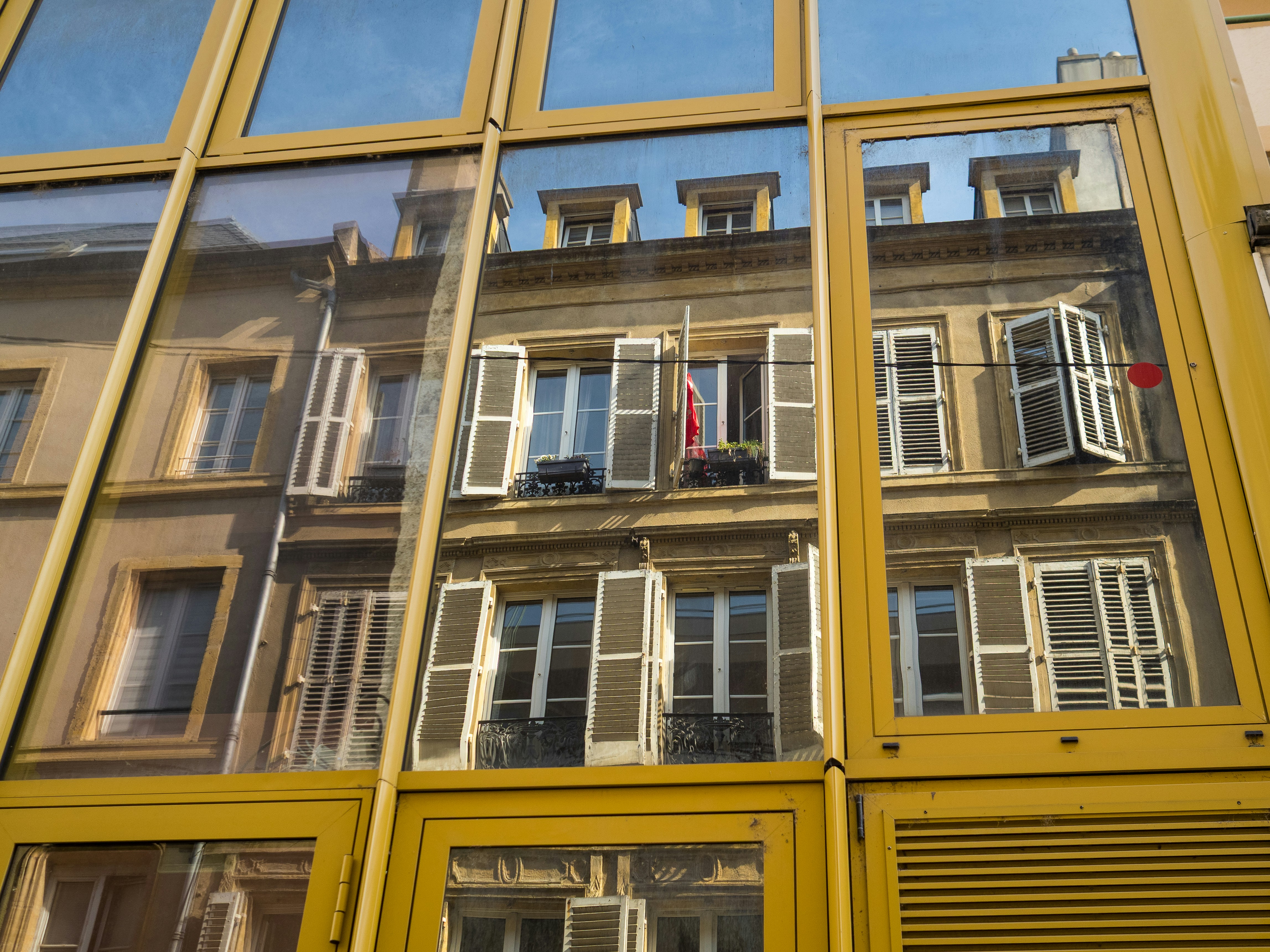 Golden Glass, Quiet City: Reflected Facade and Window Grid