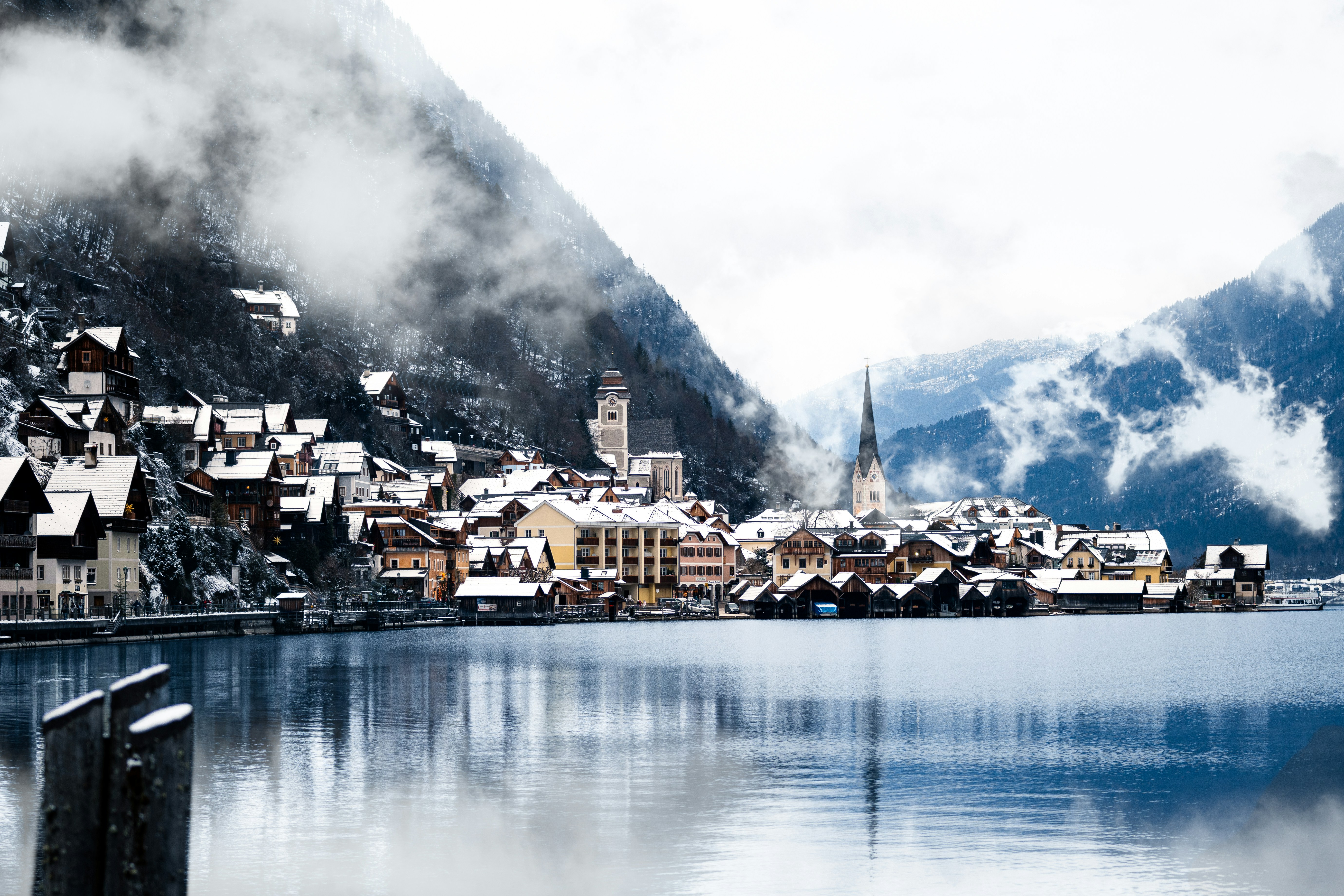 Snow-covered village on a lake with mountains. photo – Free Lake Image ...