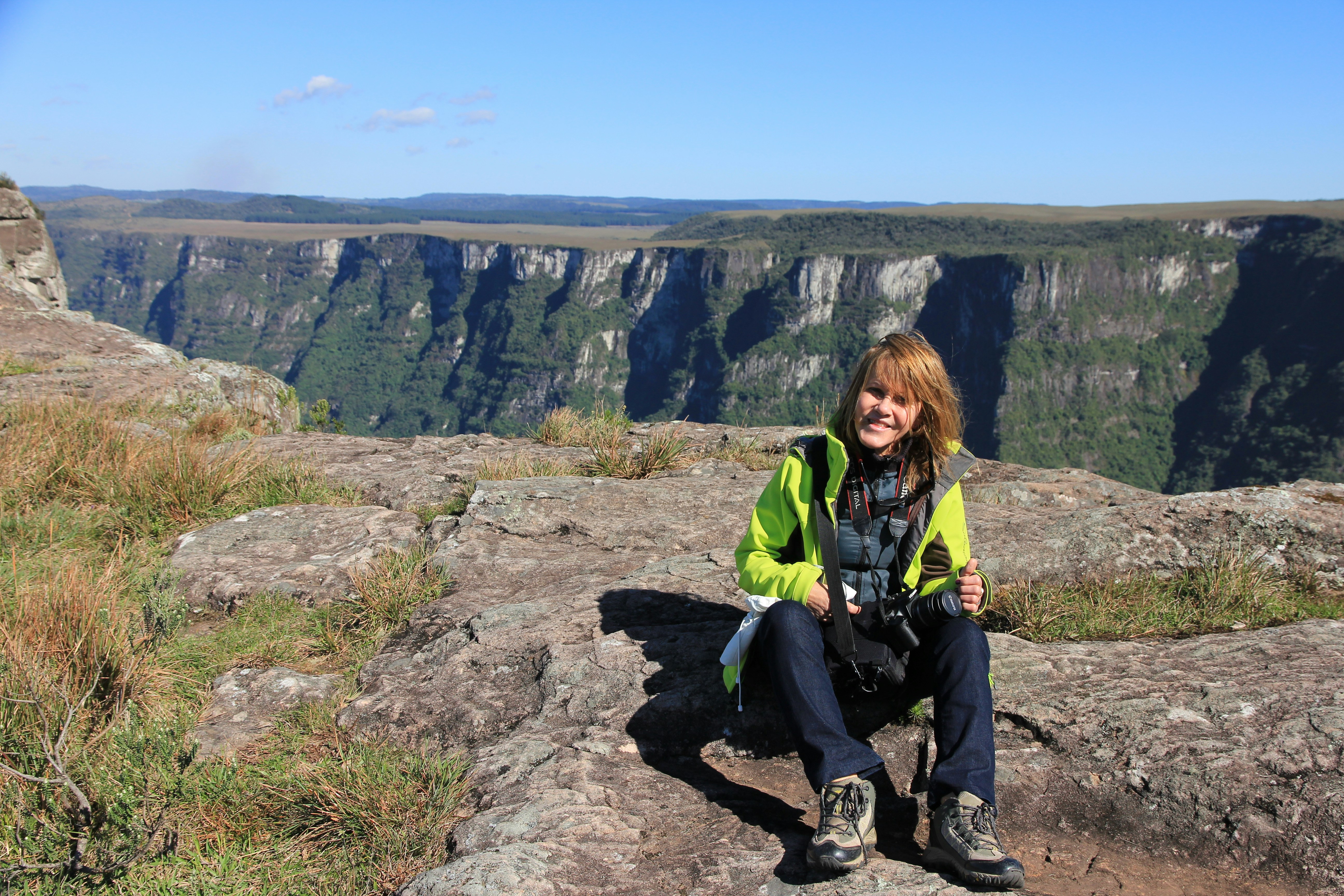 Hiker at the Cliff's Edge: A Quiet Moment Above the Gorge