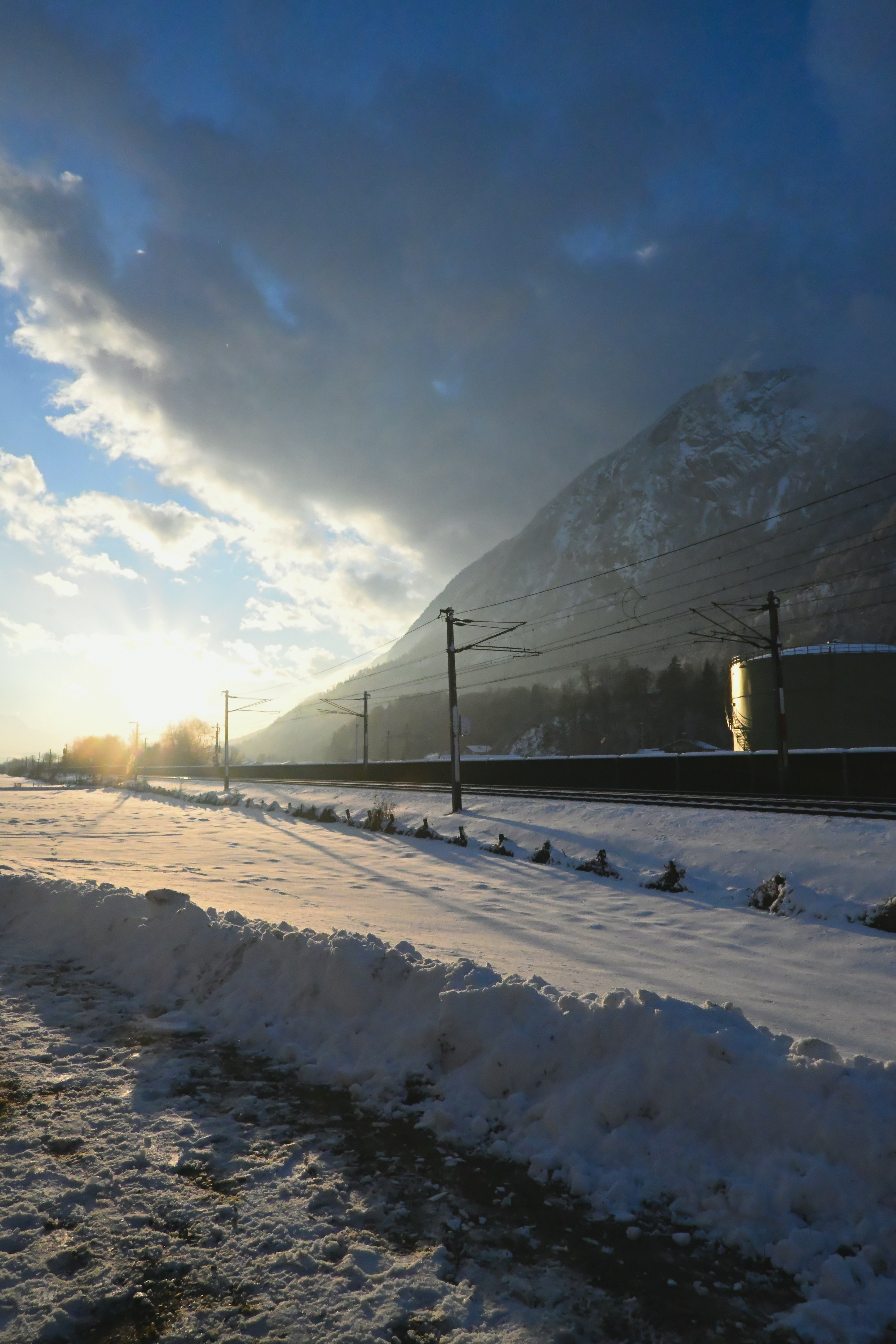 Sunrise over a Snowbound Rail Line in the Shadow of a Mountain