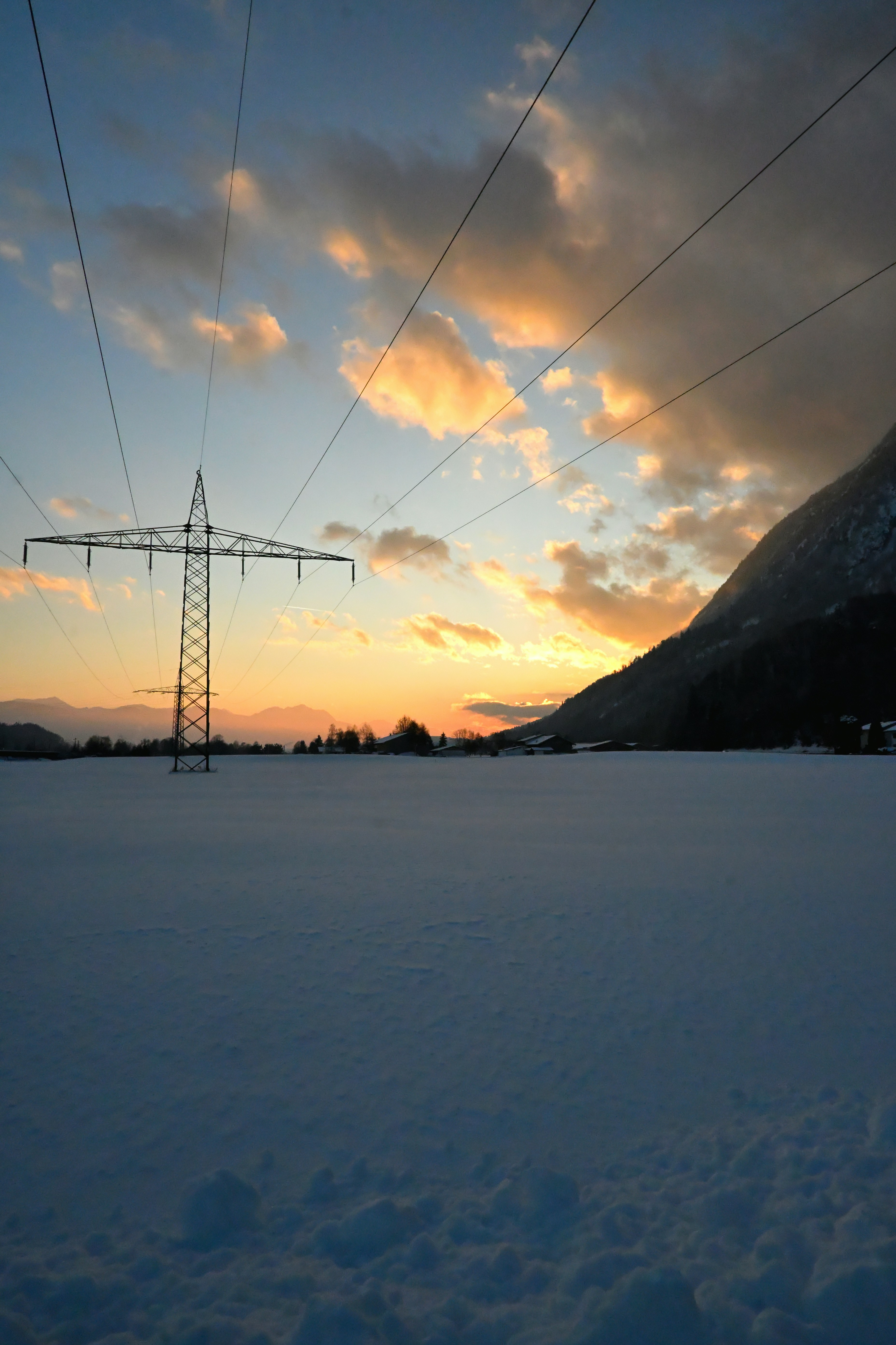 Sunset Conductor: Snowfield Beneath a Sky of Cords