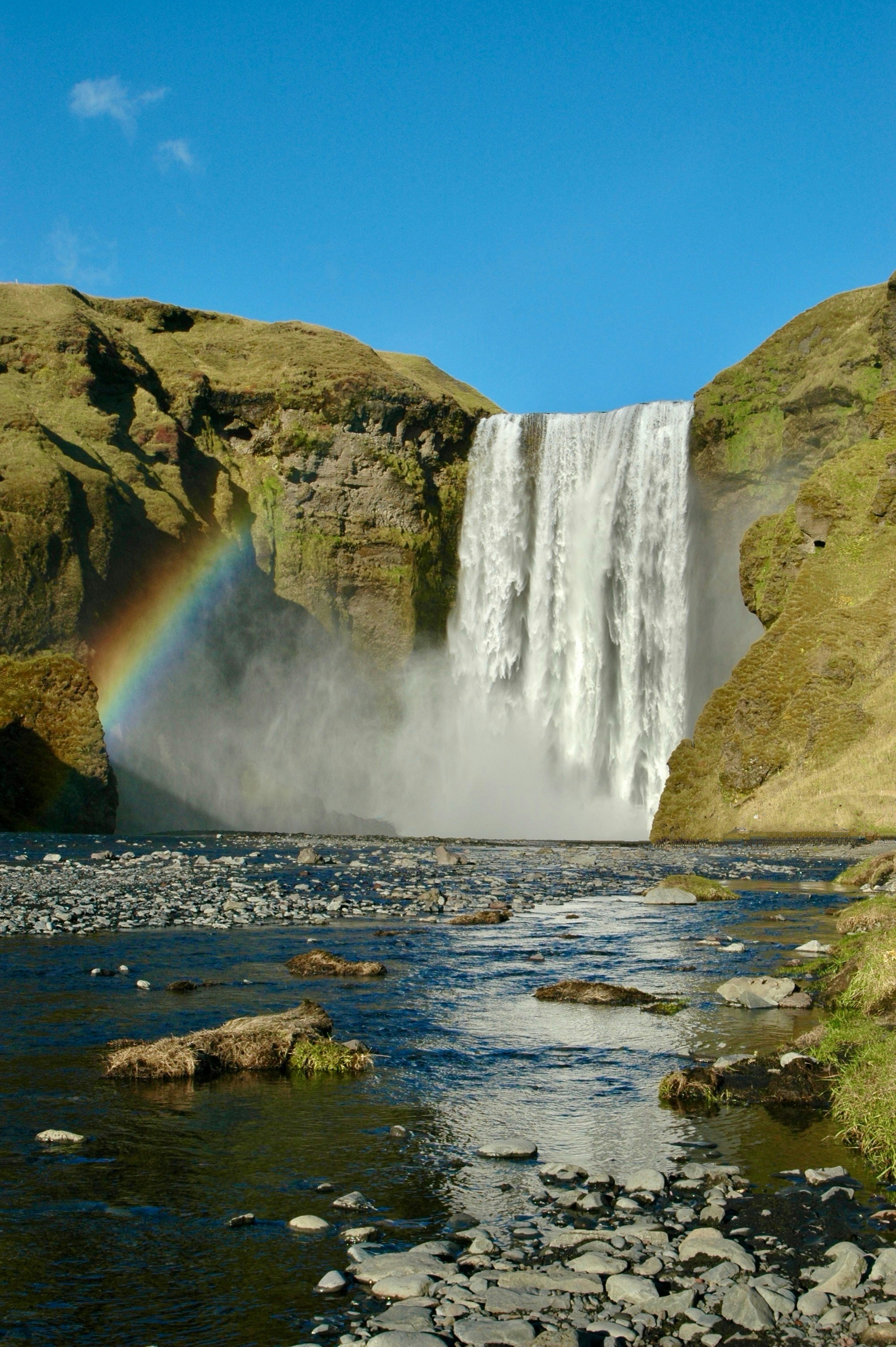 Rainbow at the Edge: Cascade of Skógafoss Framing the Morning Light
