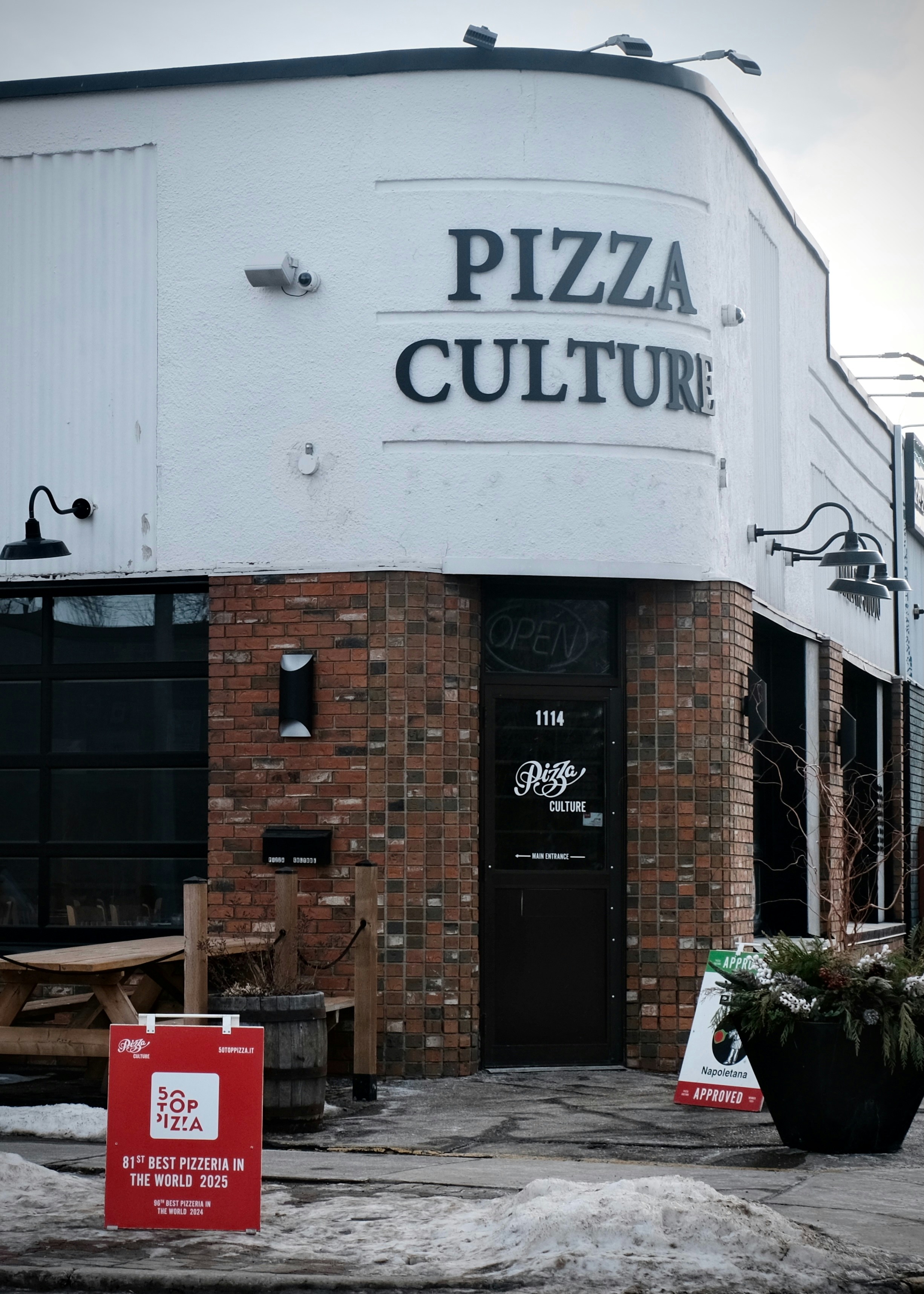 Pizza Culture Facade: A Brick-and-White Corner Eatery with Open Signage
