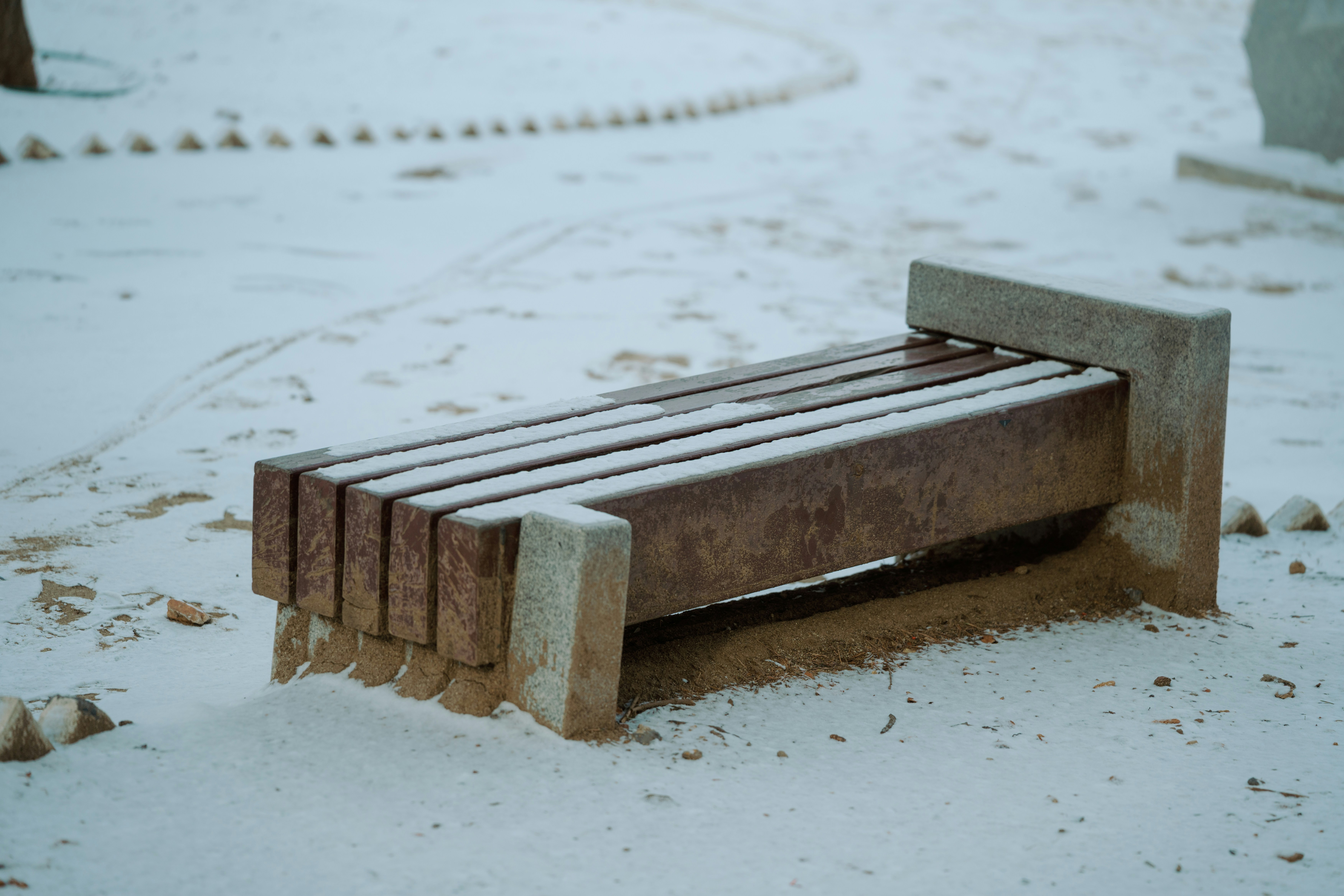 Weathered wooden bench resting on pale sand