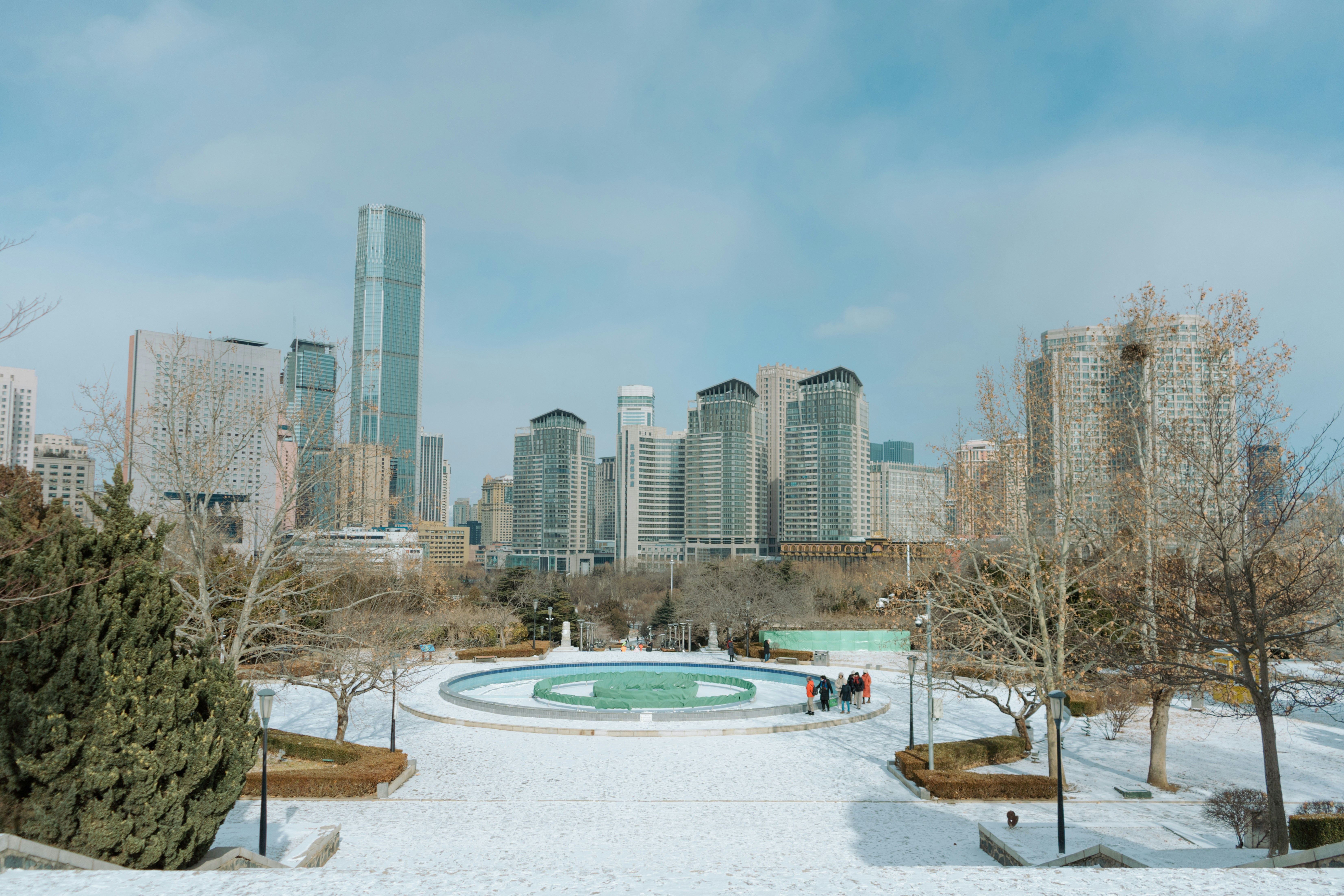 Snowbound Confluence: urban skyline framed by a frosted plaza