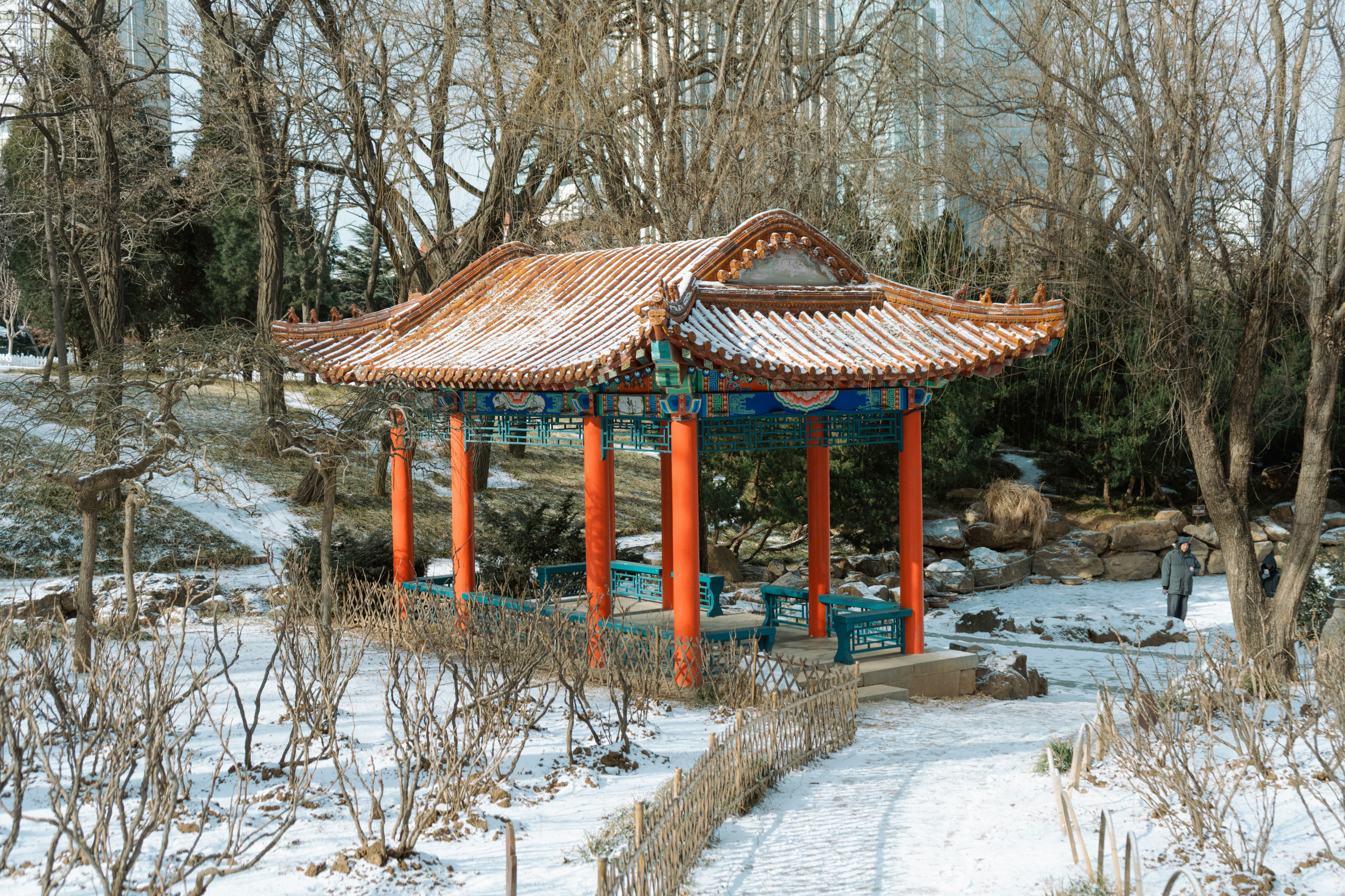 Winter's Red-Paced Pavilion in a Snow-Silvered Garden