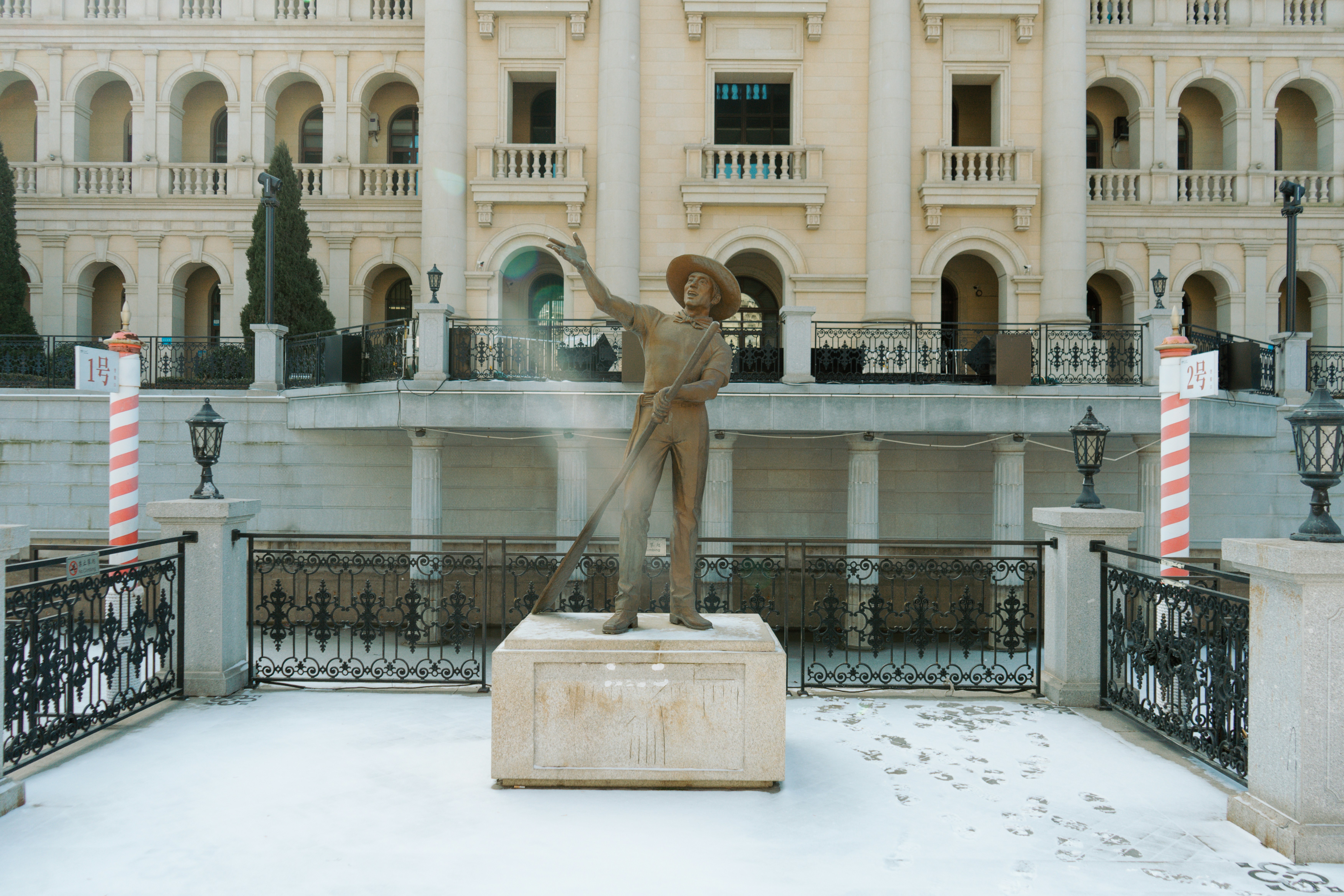 Statue at the Courtyard Framed by Classical Facade