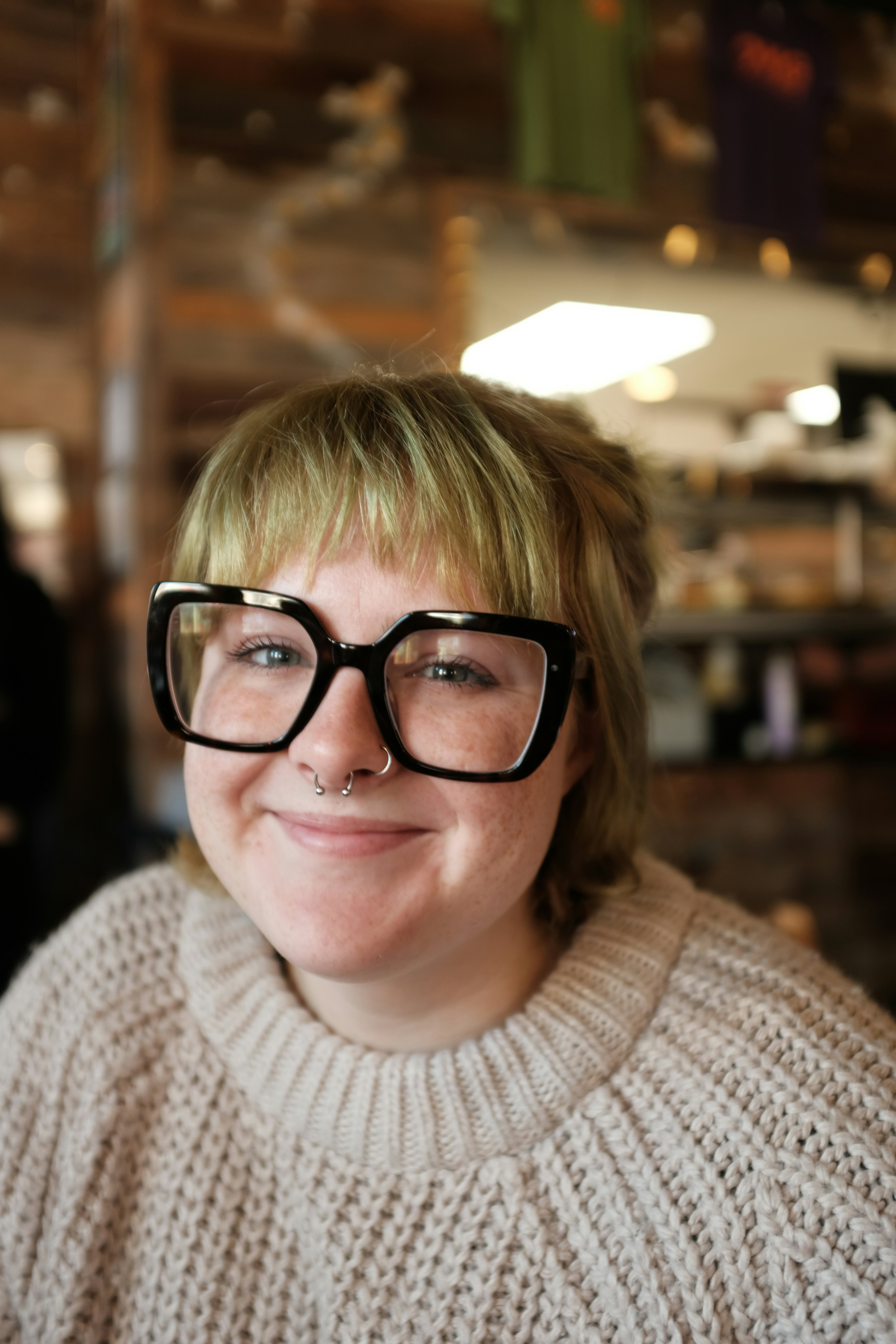 Glasses, Smile, and Warm Light: A Portrait in Cozy Cafe Vibe