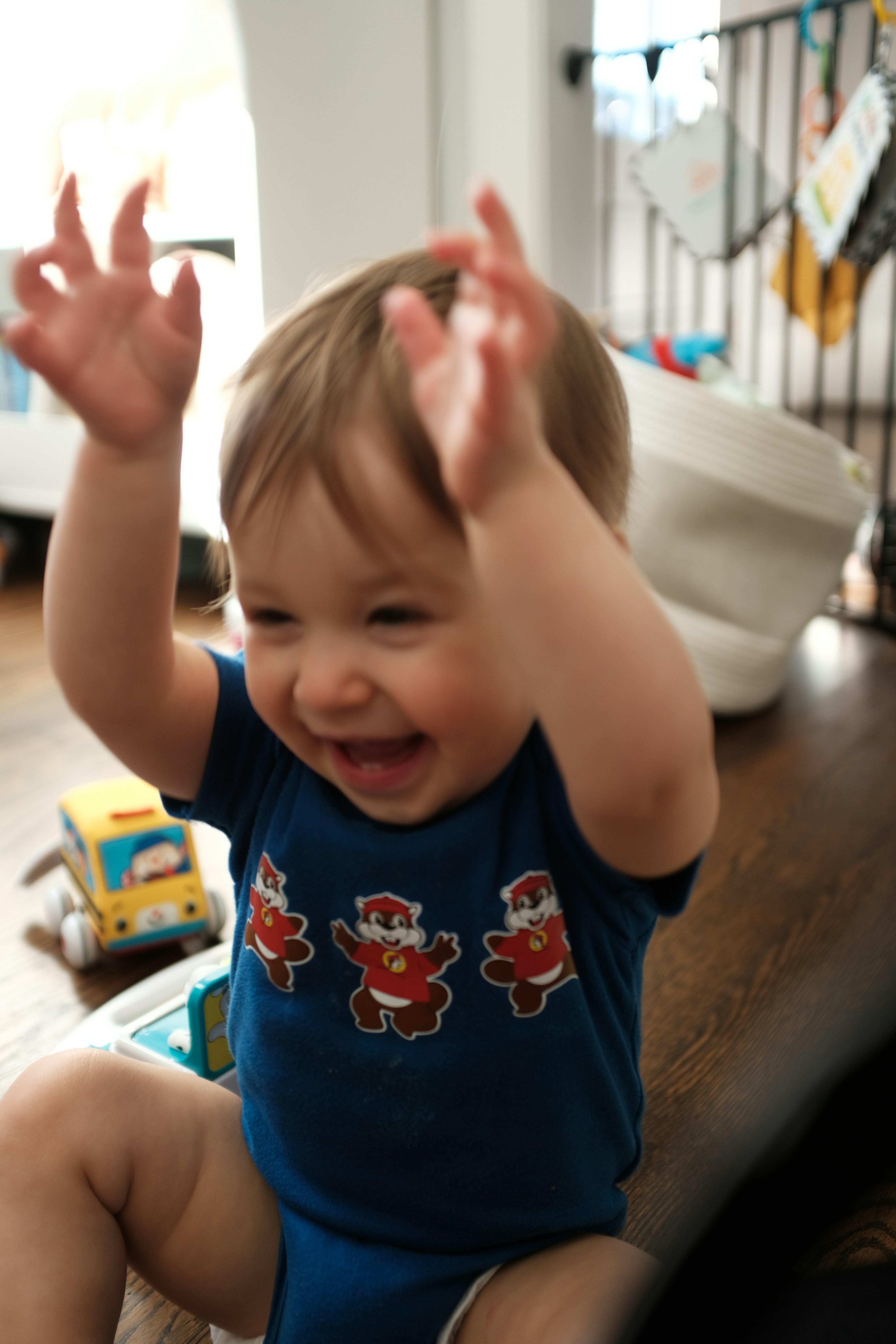 Joyful Reach: A toddler's exuberant celebration indoors
