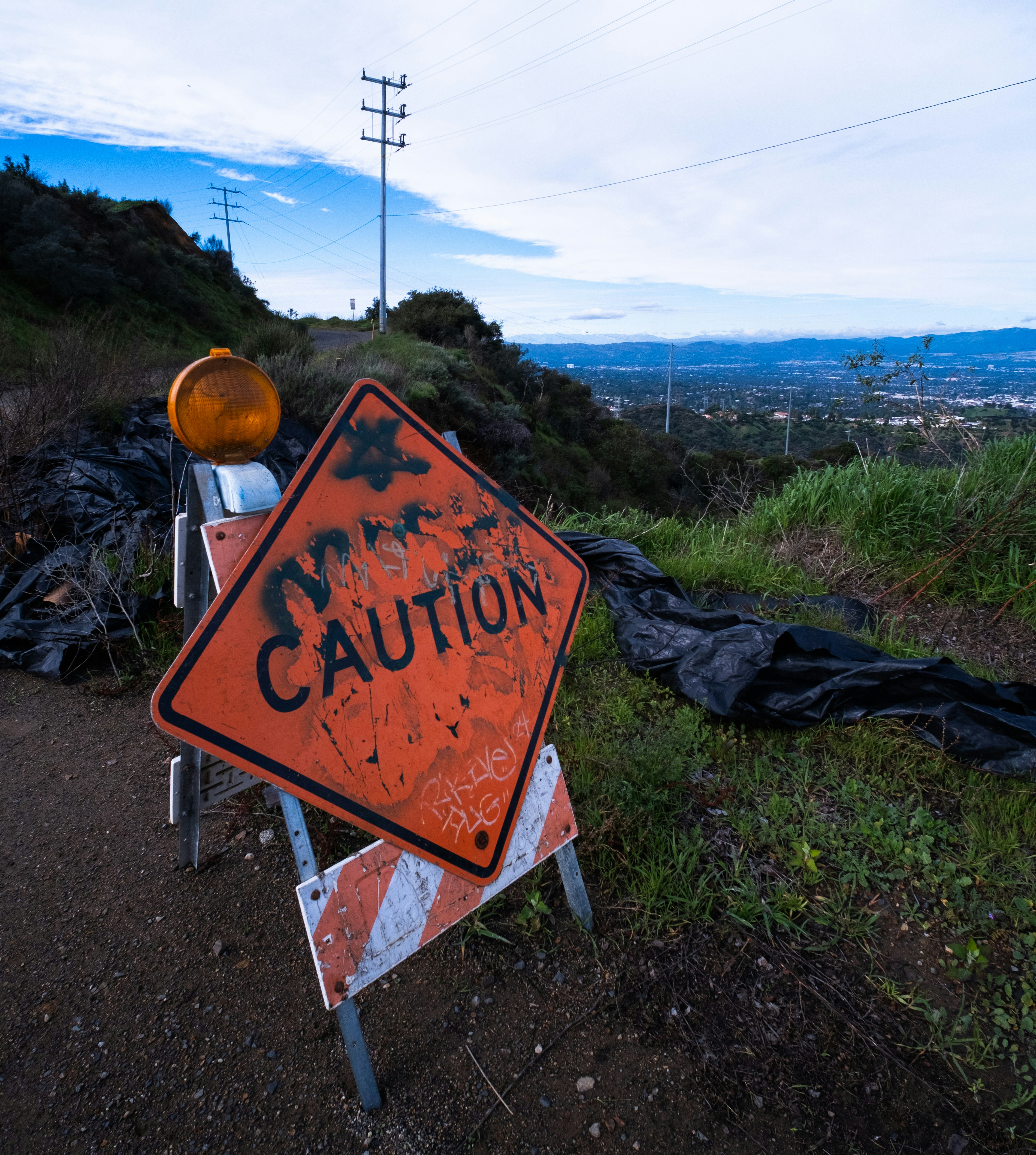 Orange caution sign on a construction barrier