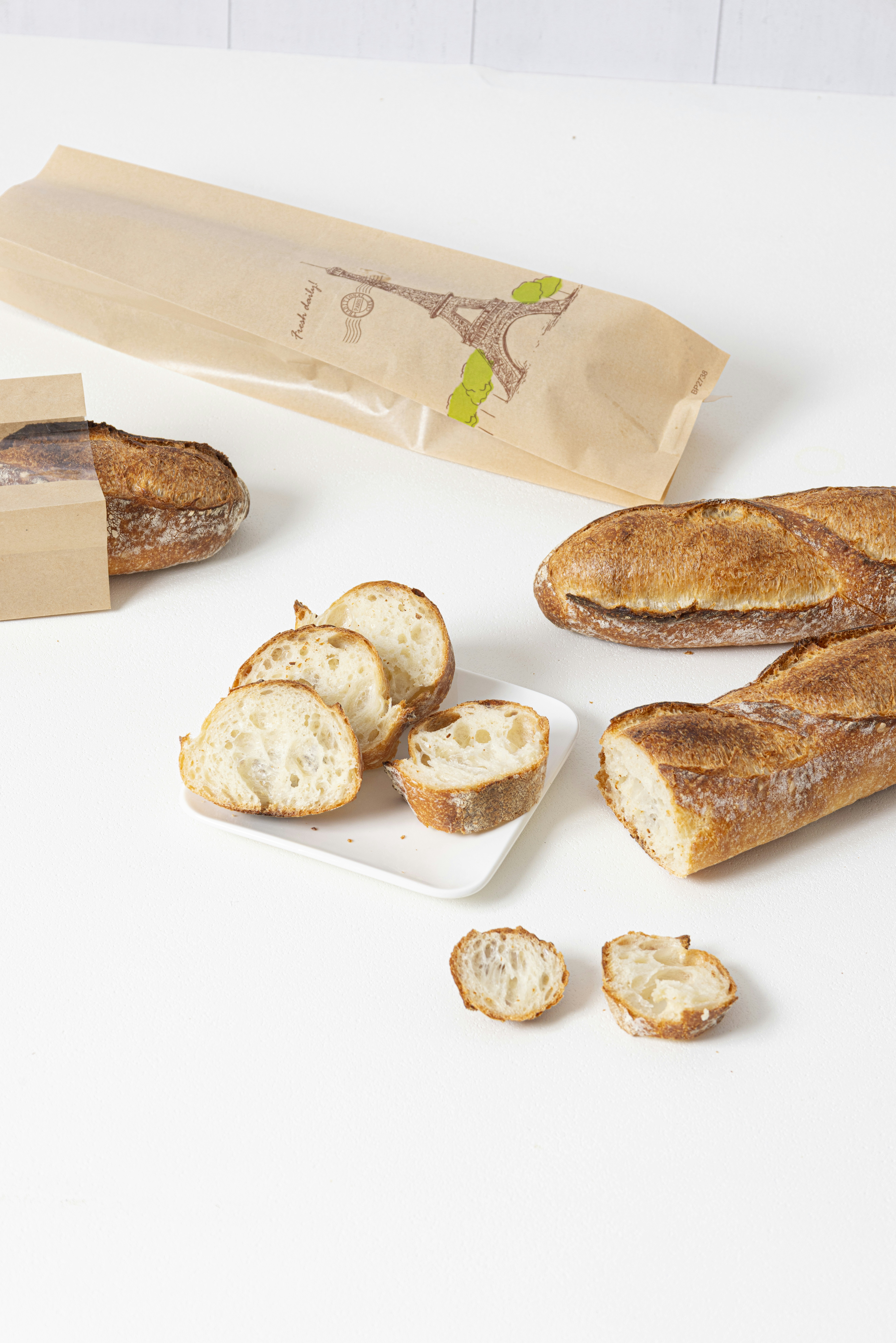 French baguettes and sliced bread on a white surface photo – Free Food ...