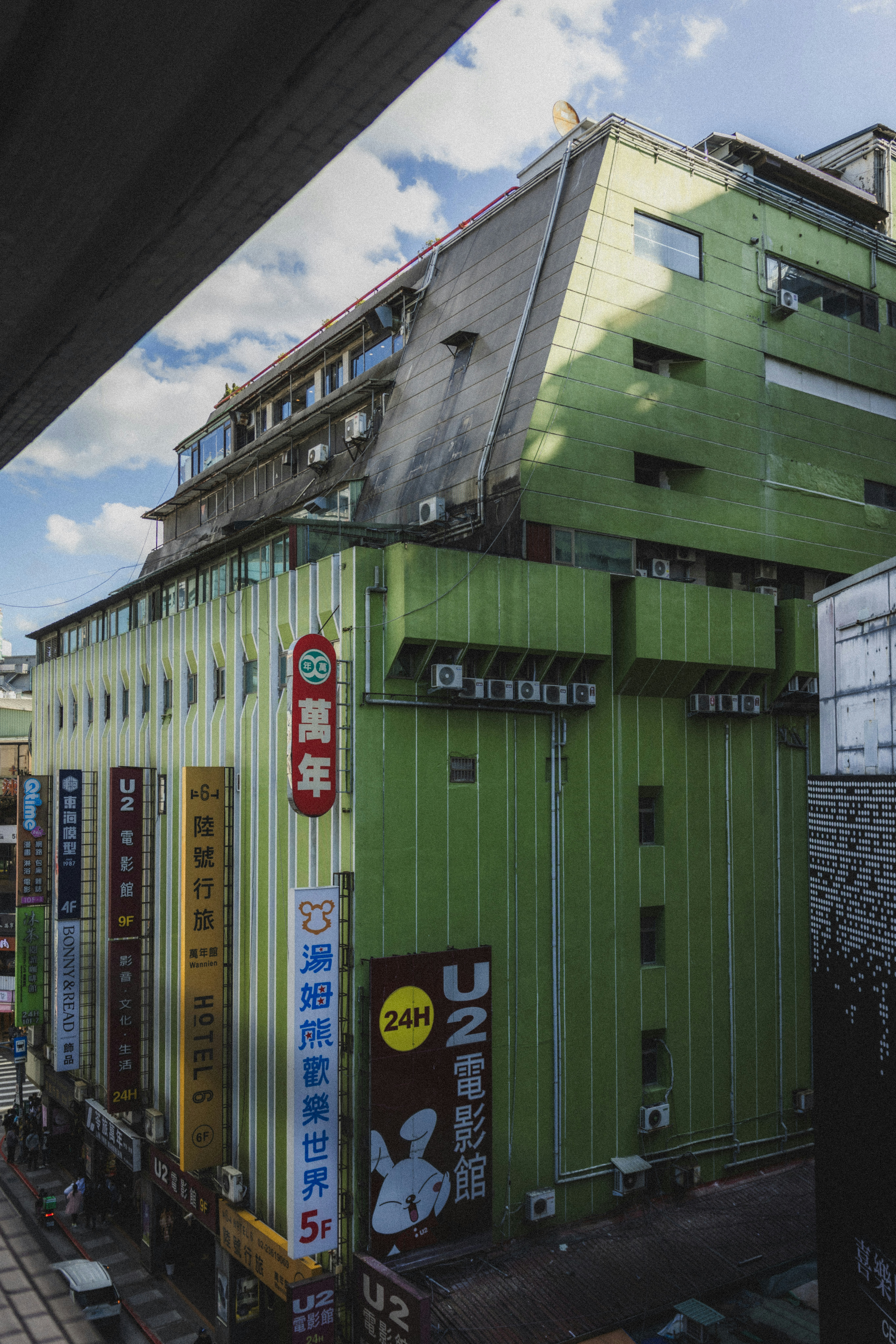 Vibrant Urban Facade: Neon Signs and Green Architecture