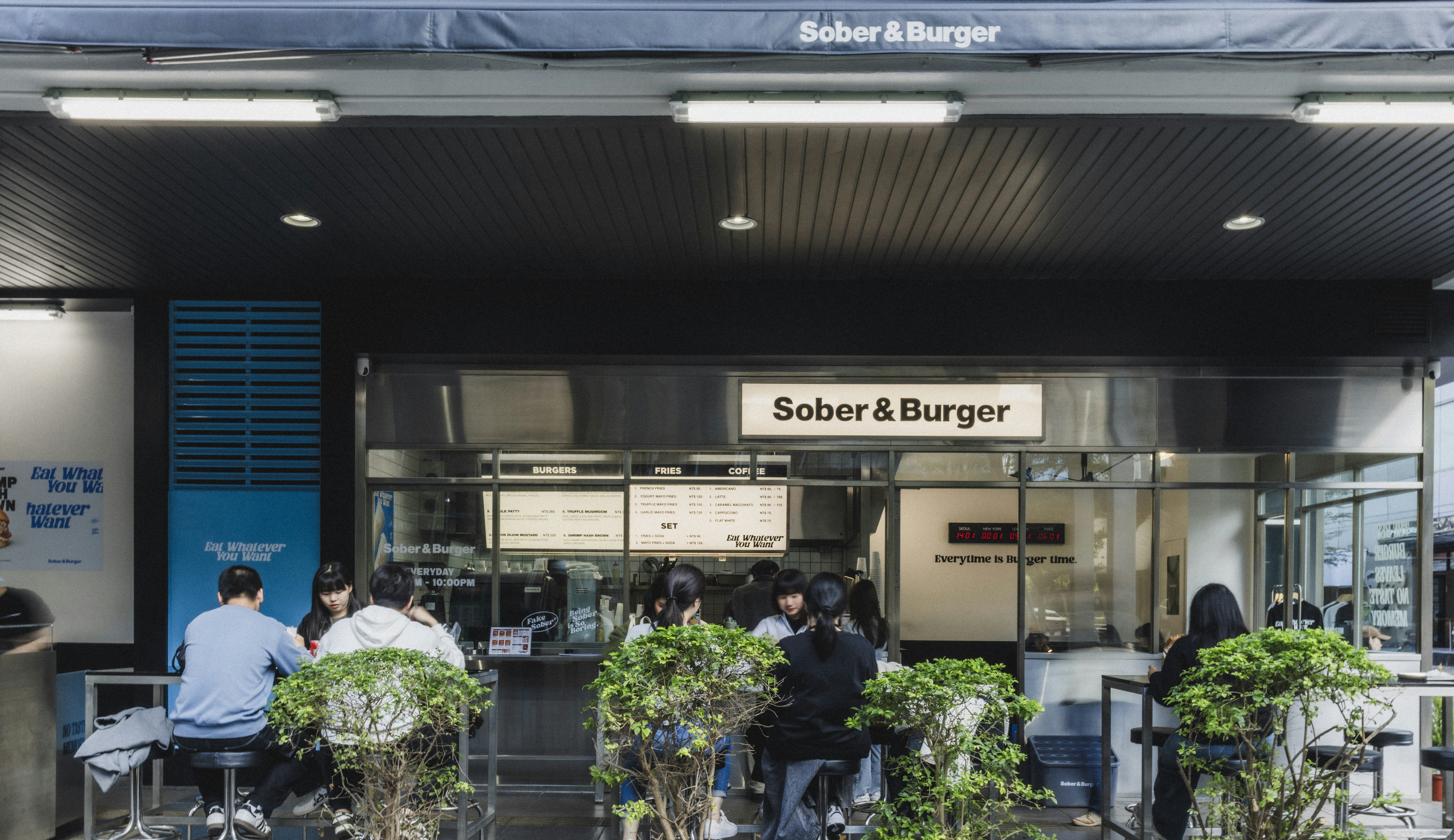 Sippers and Screens: Casual Queue at a Sober & Burger Window